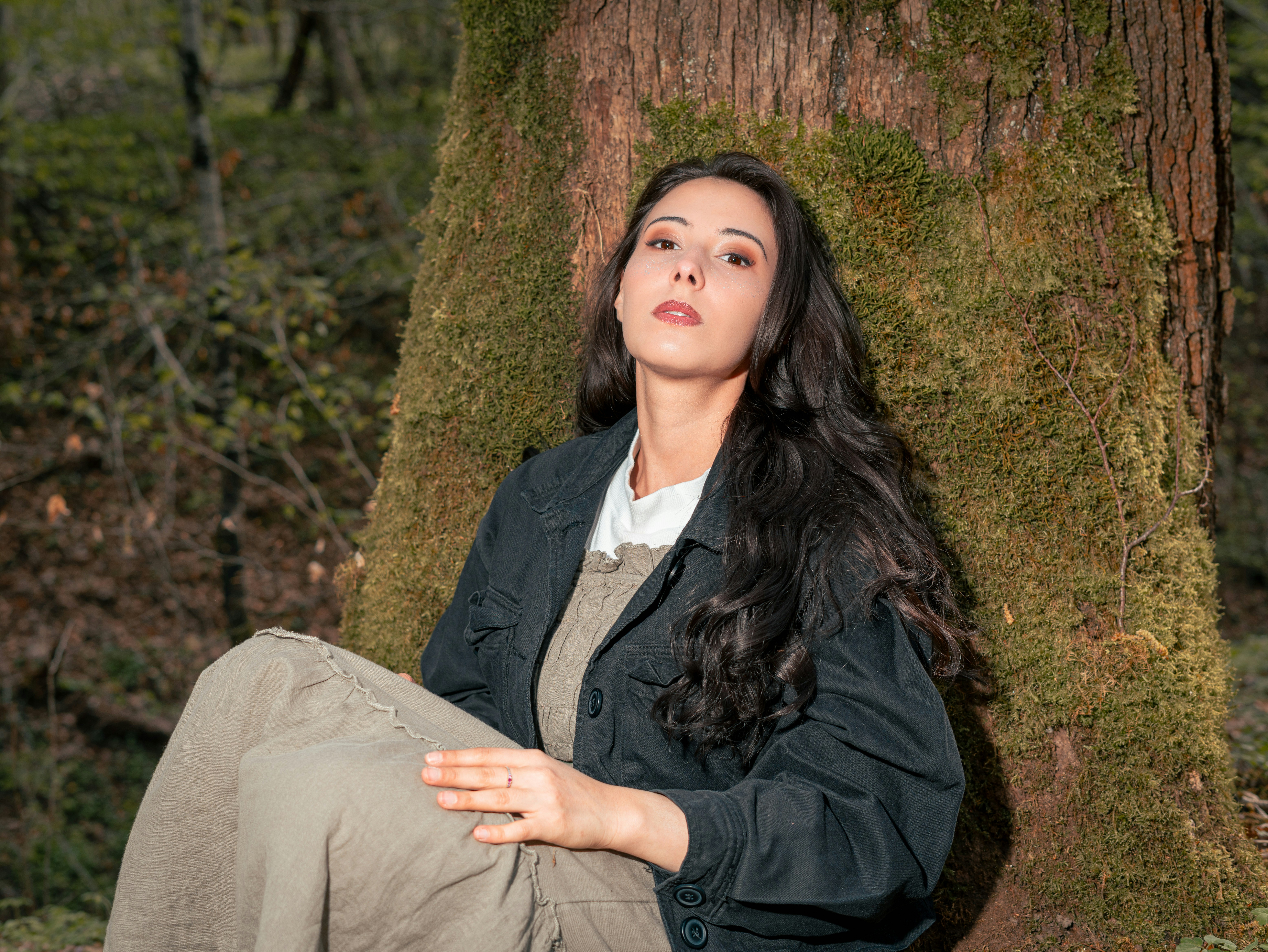 Portrait Under the Mossy Trunk