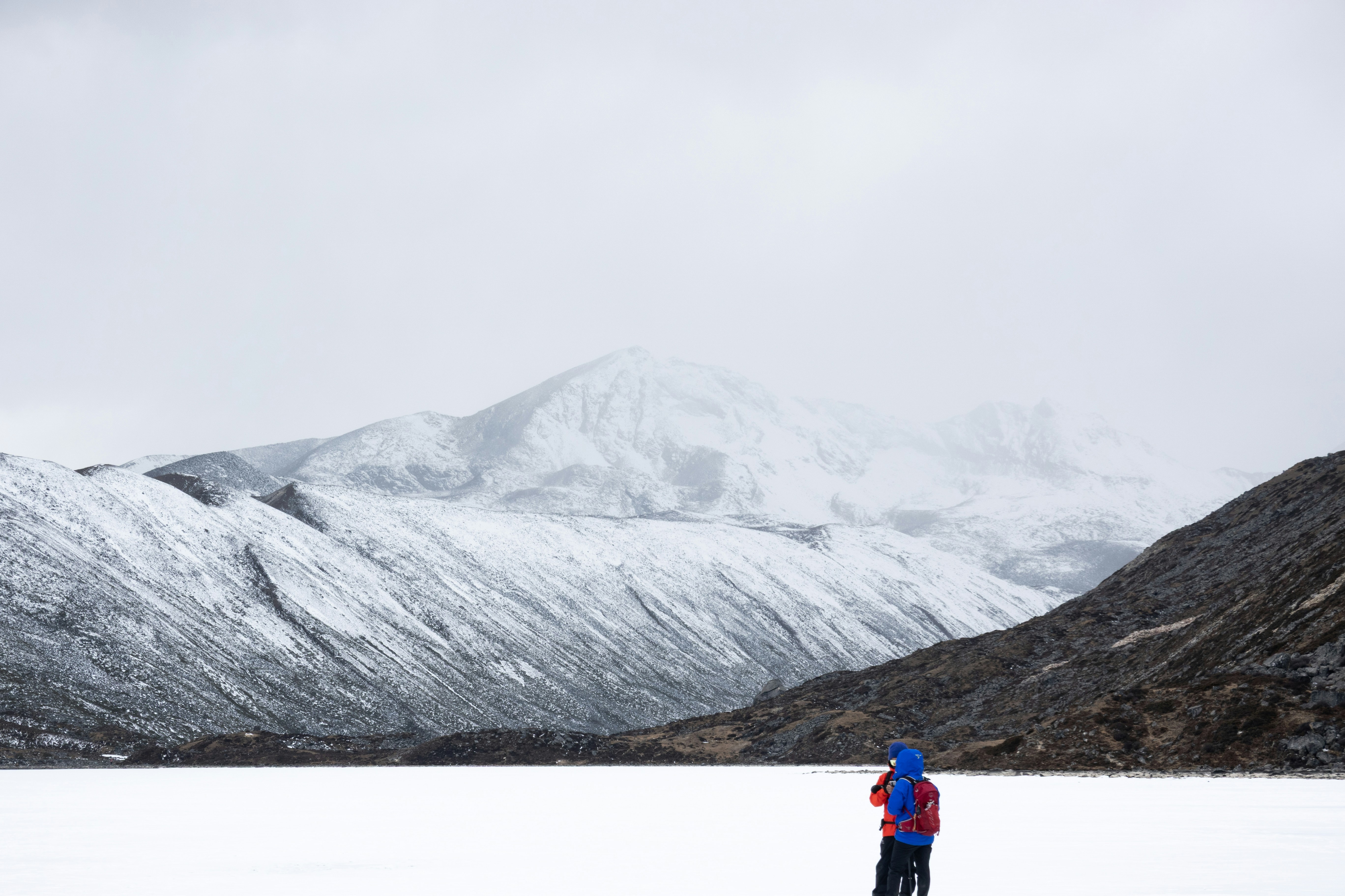 A Lone Explorer Anchored Against Snow-Capped Silence