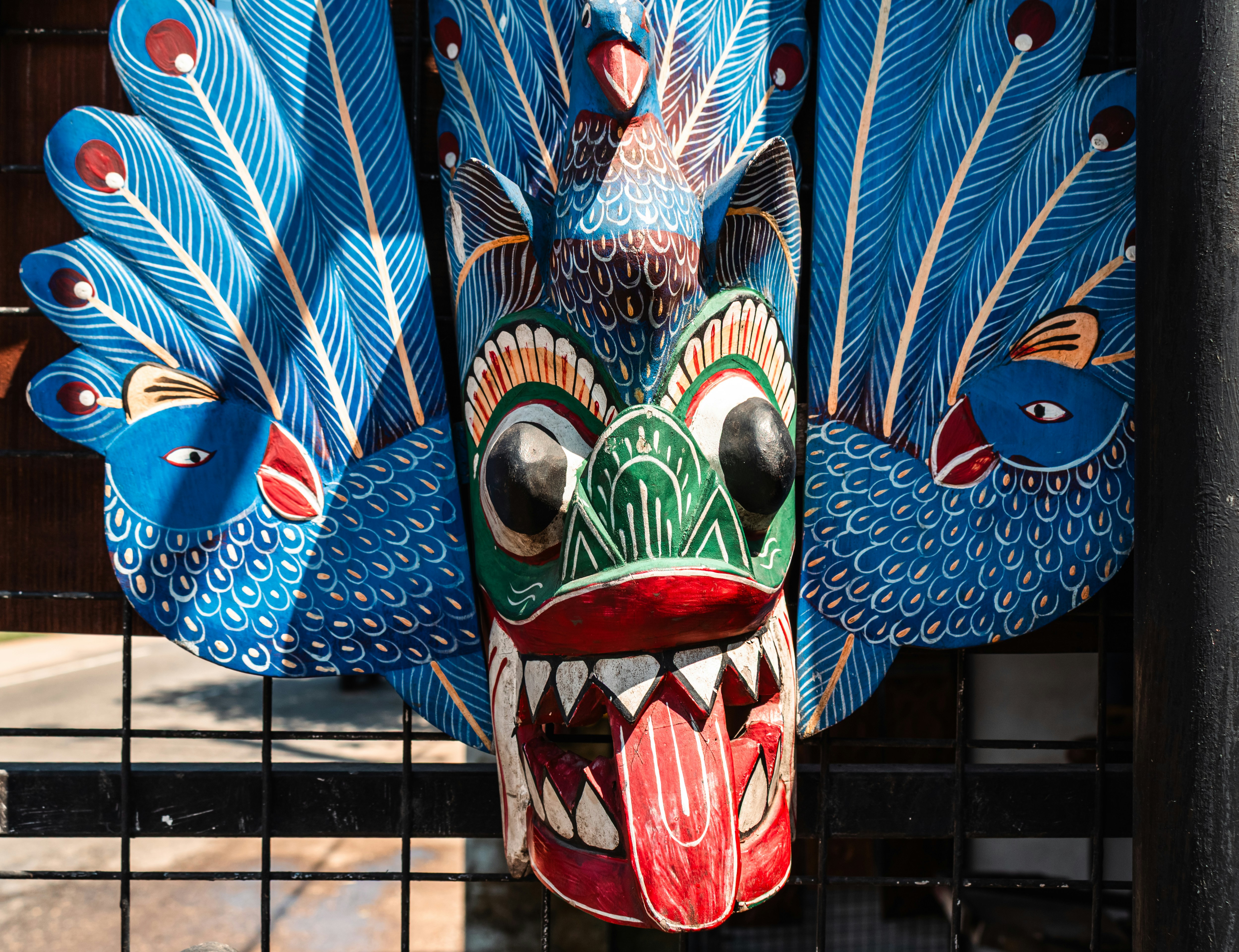 Colorful Dragon Mask on a Blackened Fence