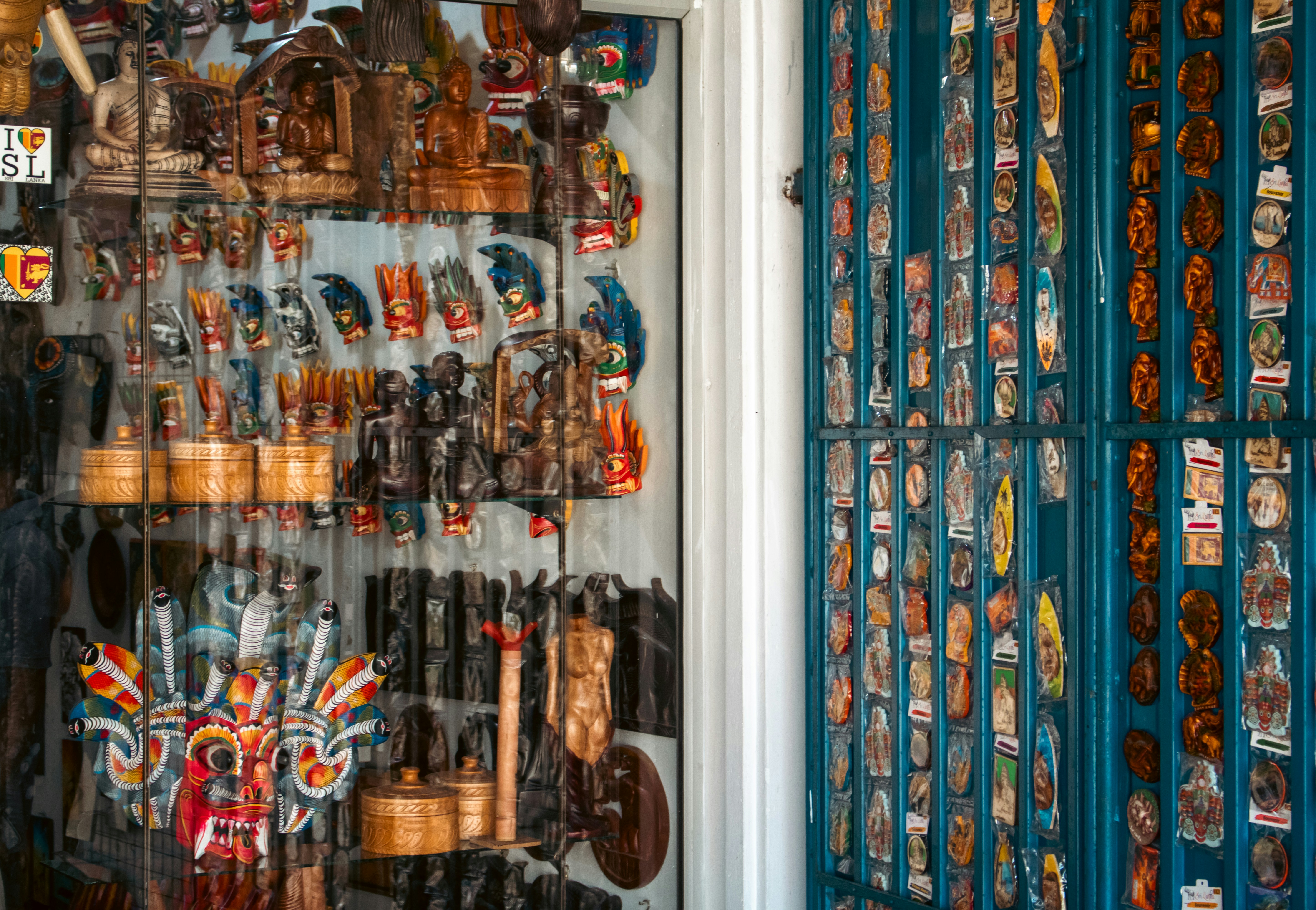 Colorful Trinket Window: Masks and Badges in a Shop