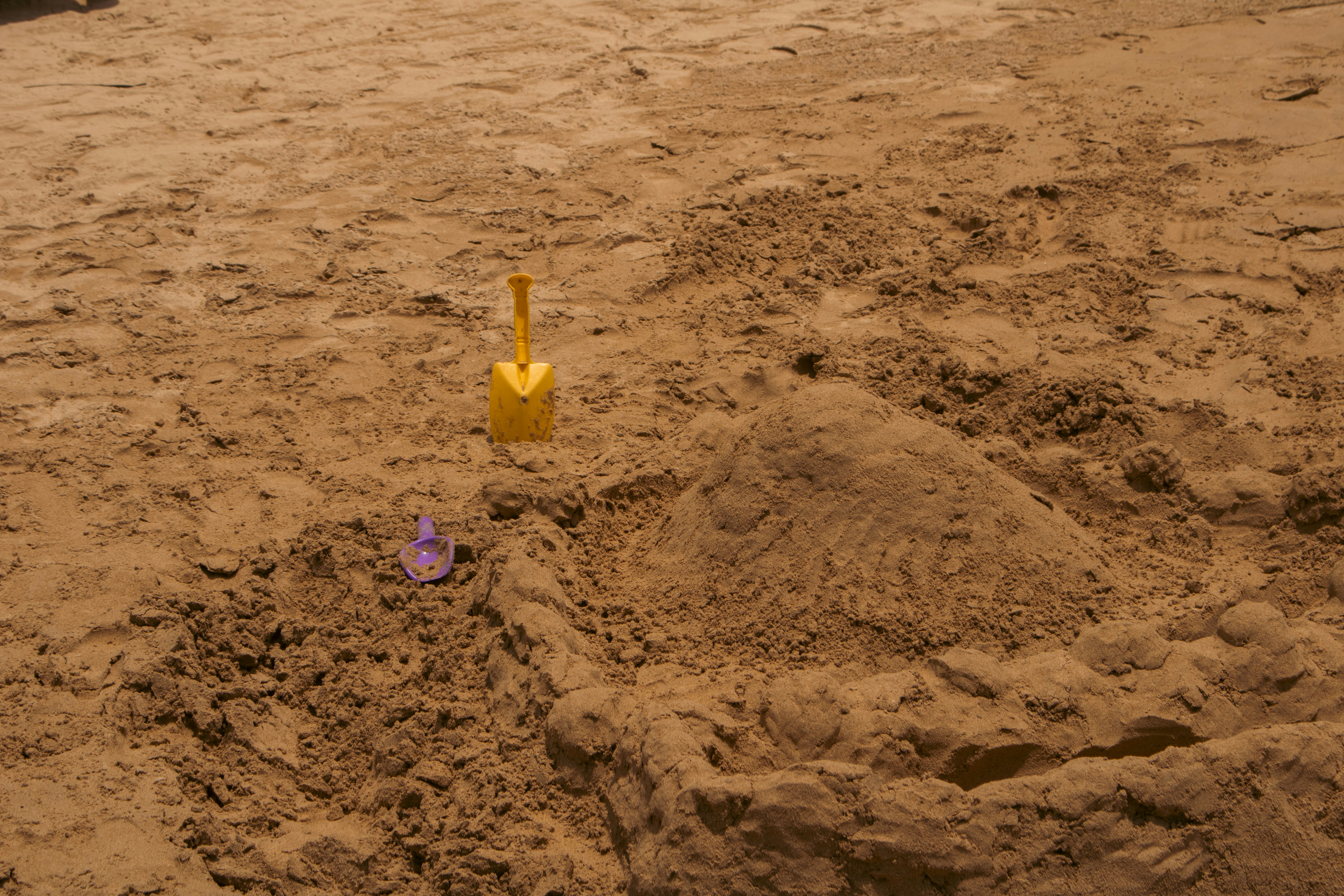 Shovel and Sandcastle Crowned by the Tide of Sunlight