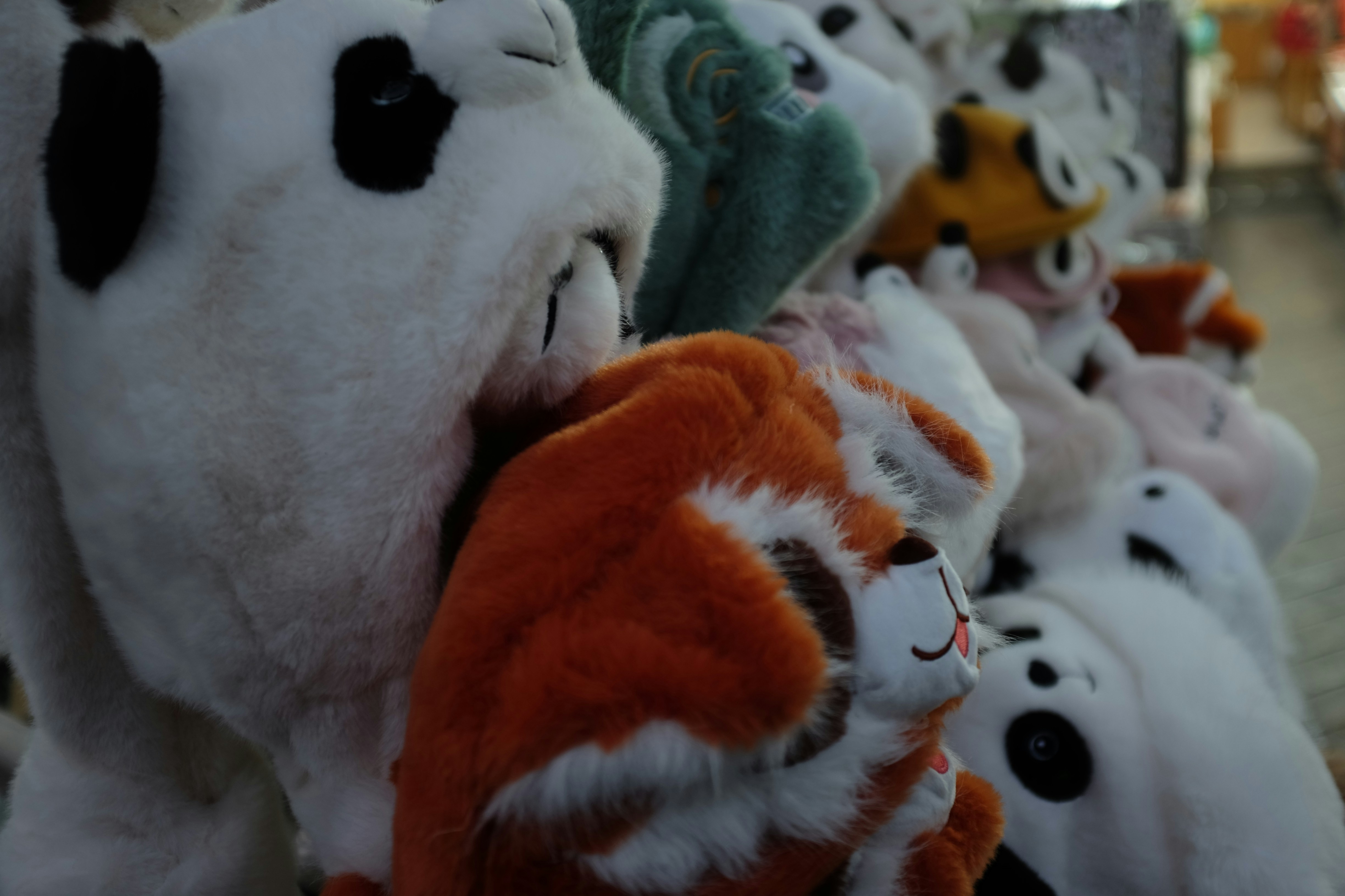 Row of Plush Panda and Fox Characters in a Market Stall