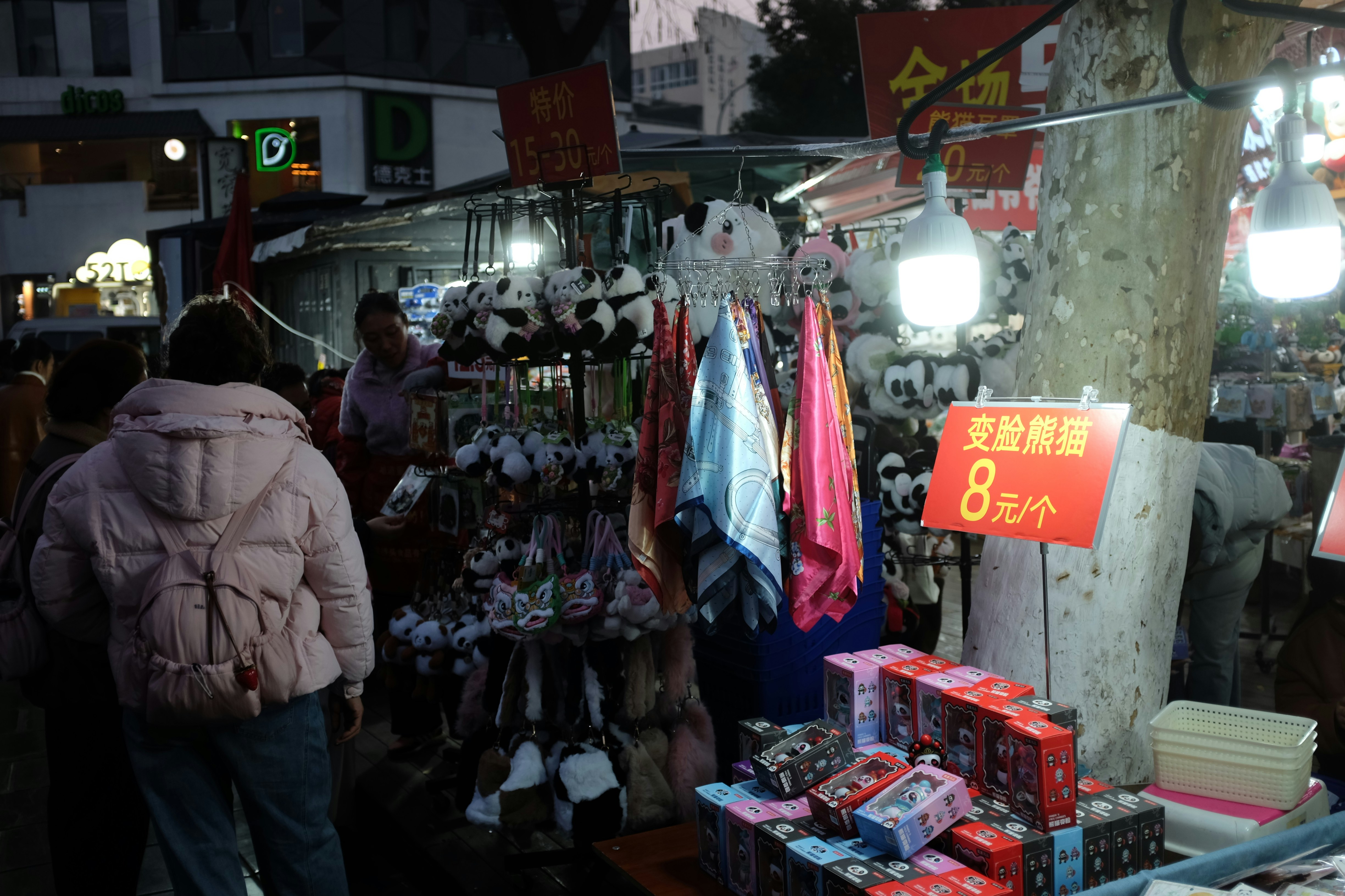 Night Market Portrait Between Banners and Plushes