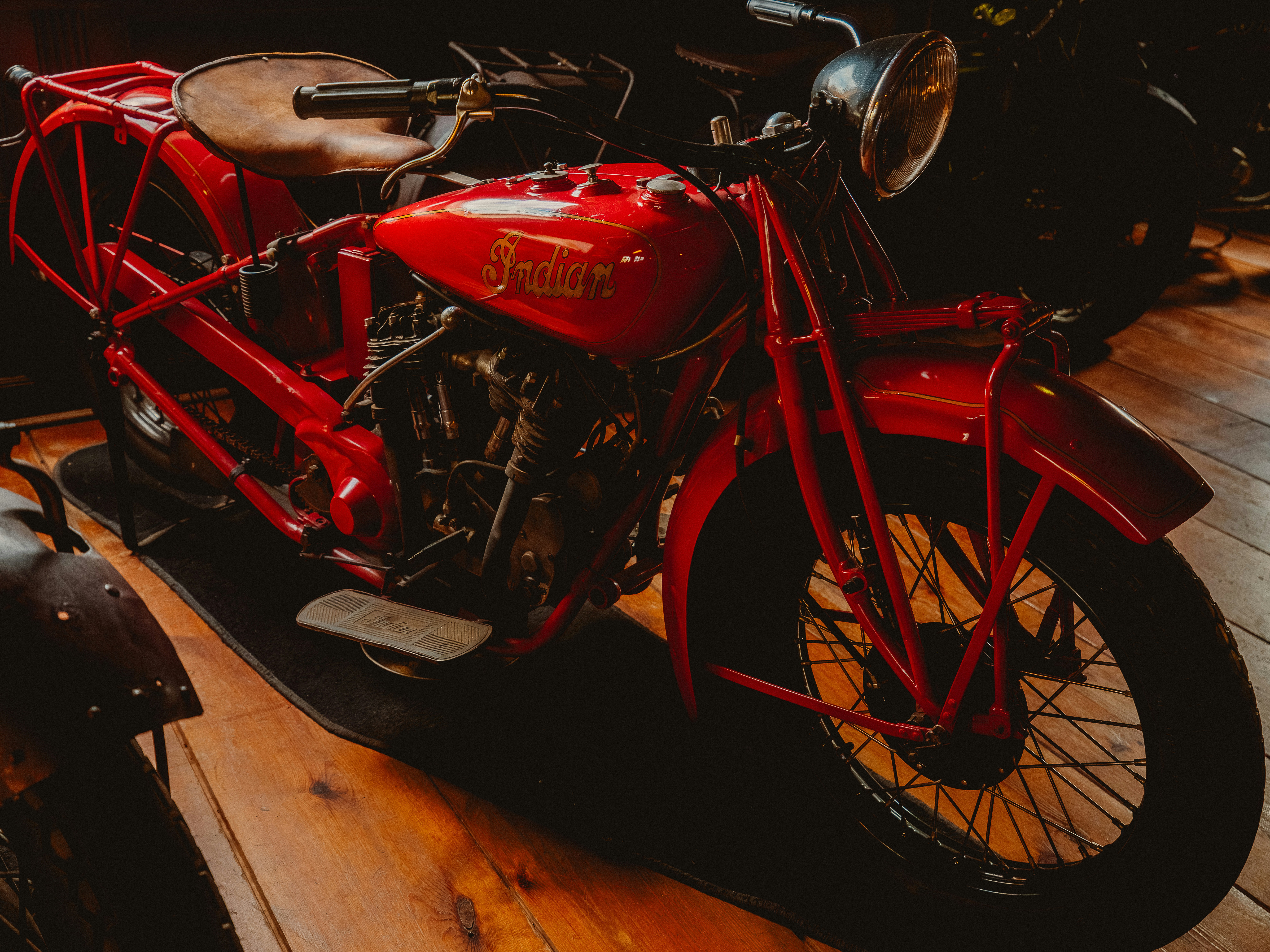 Red Iron Horse: vintage Indian motorcycle under warm showroom glow