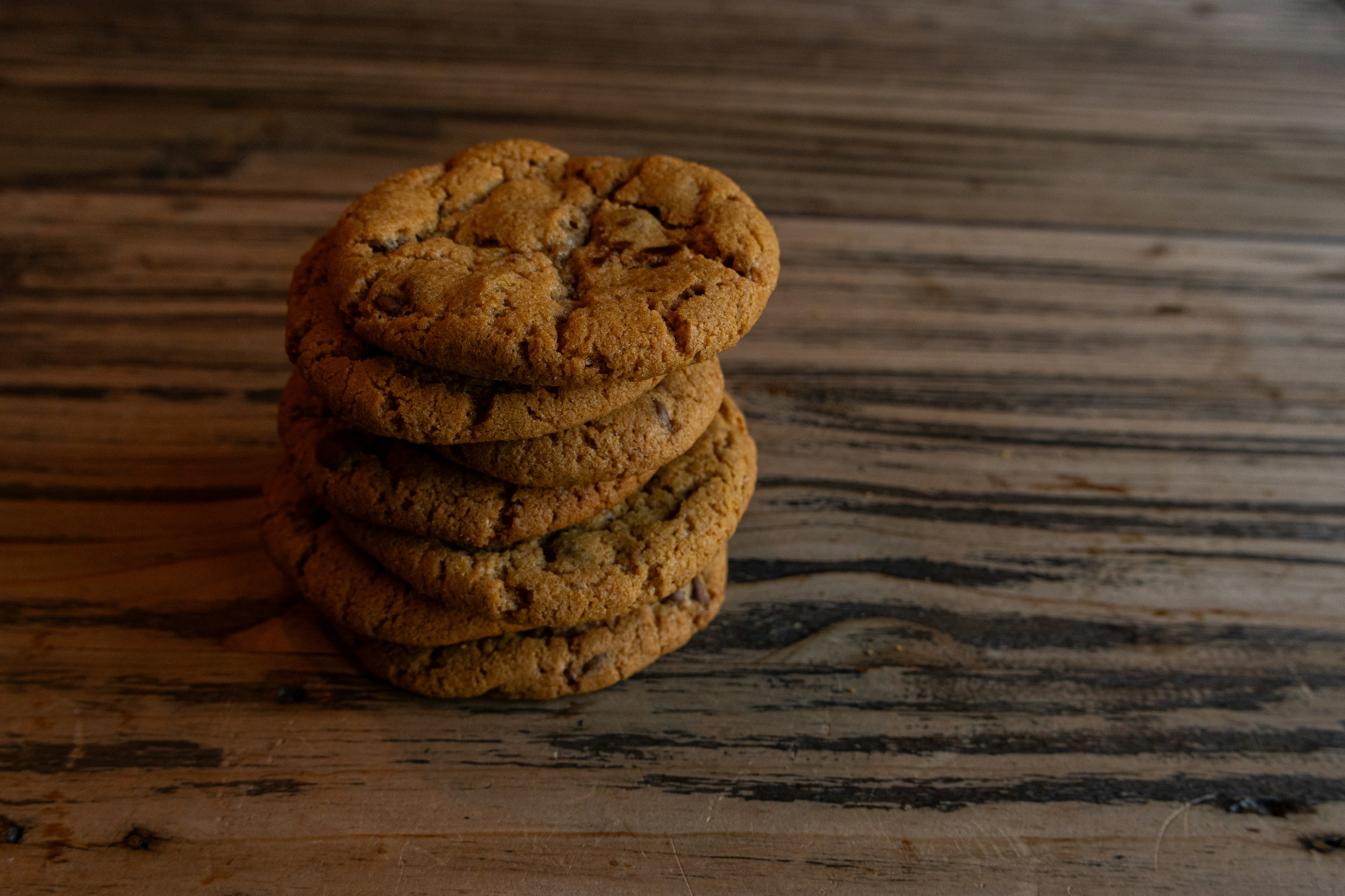 Stacked Chocolate Chip Cookies on a Rustic Wood Table