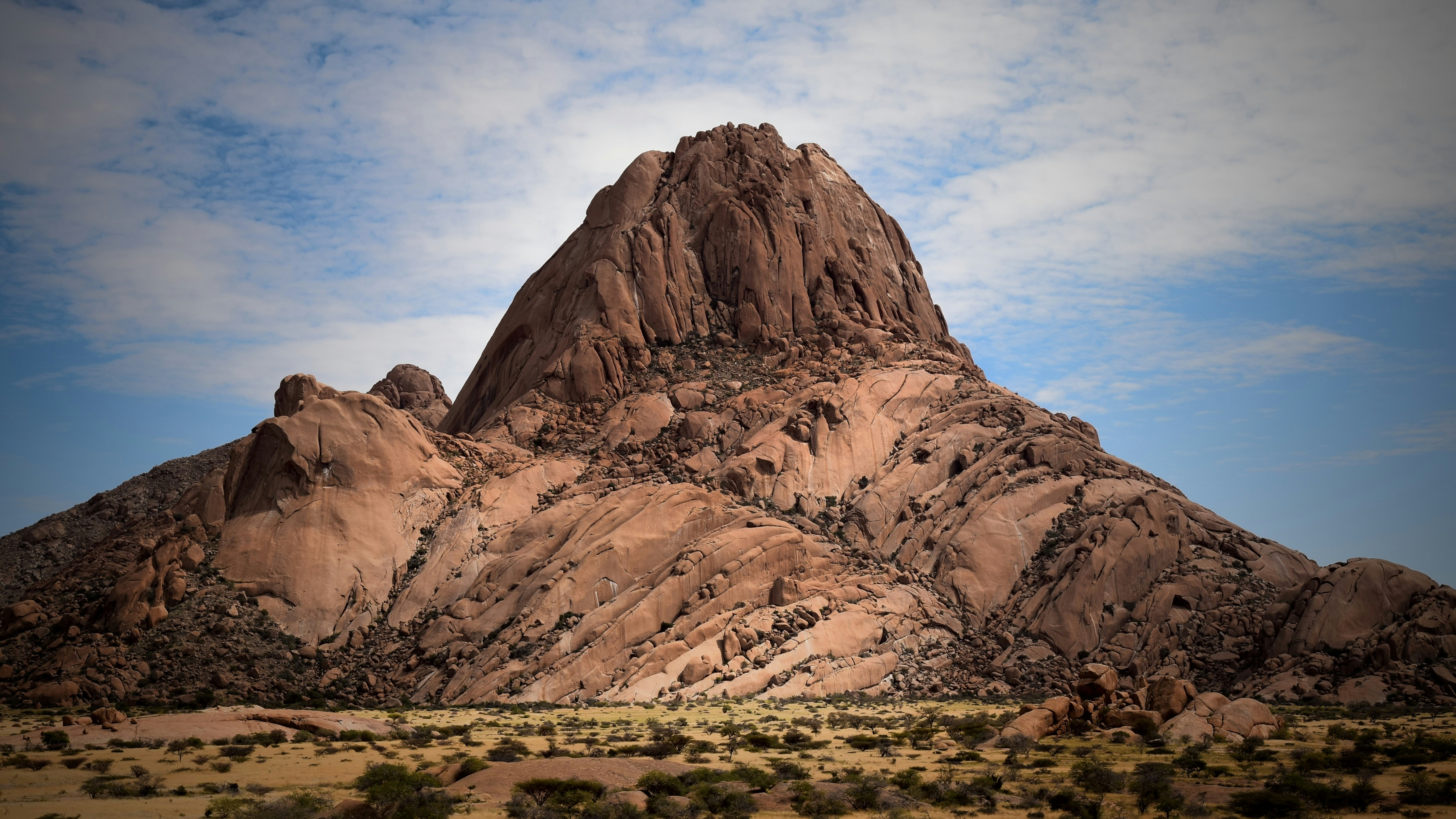 Granite Sentinel: A Lone Peak Rising Over Desert Flats