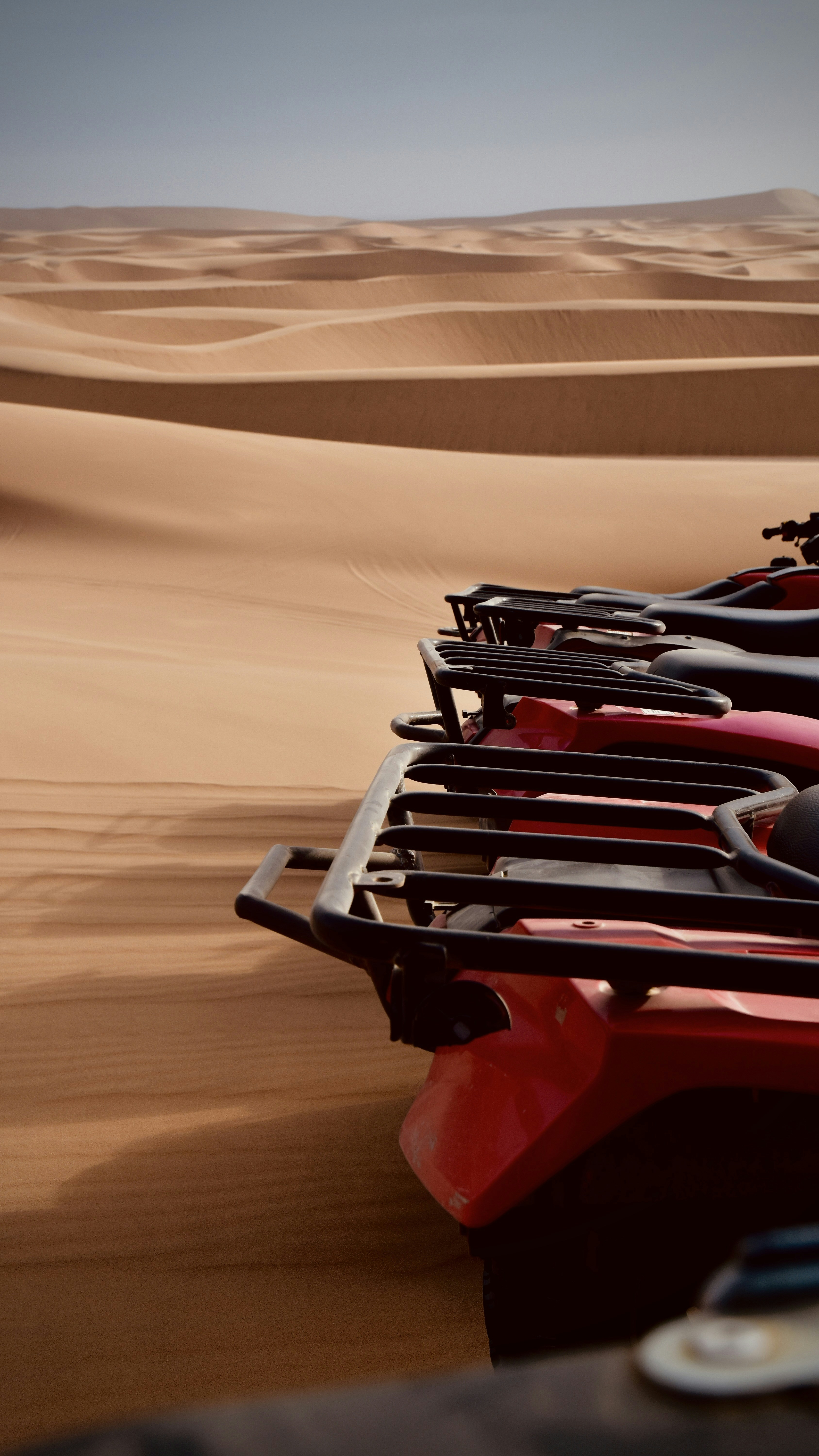 Desert Rails: Aline of ATVs Recede into Dunes