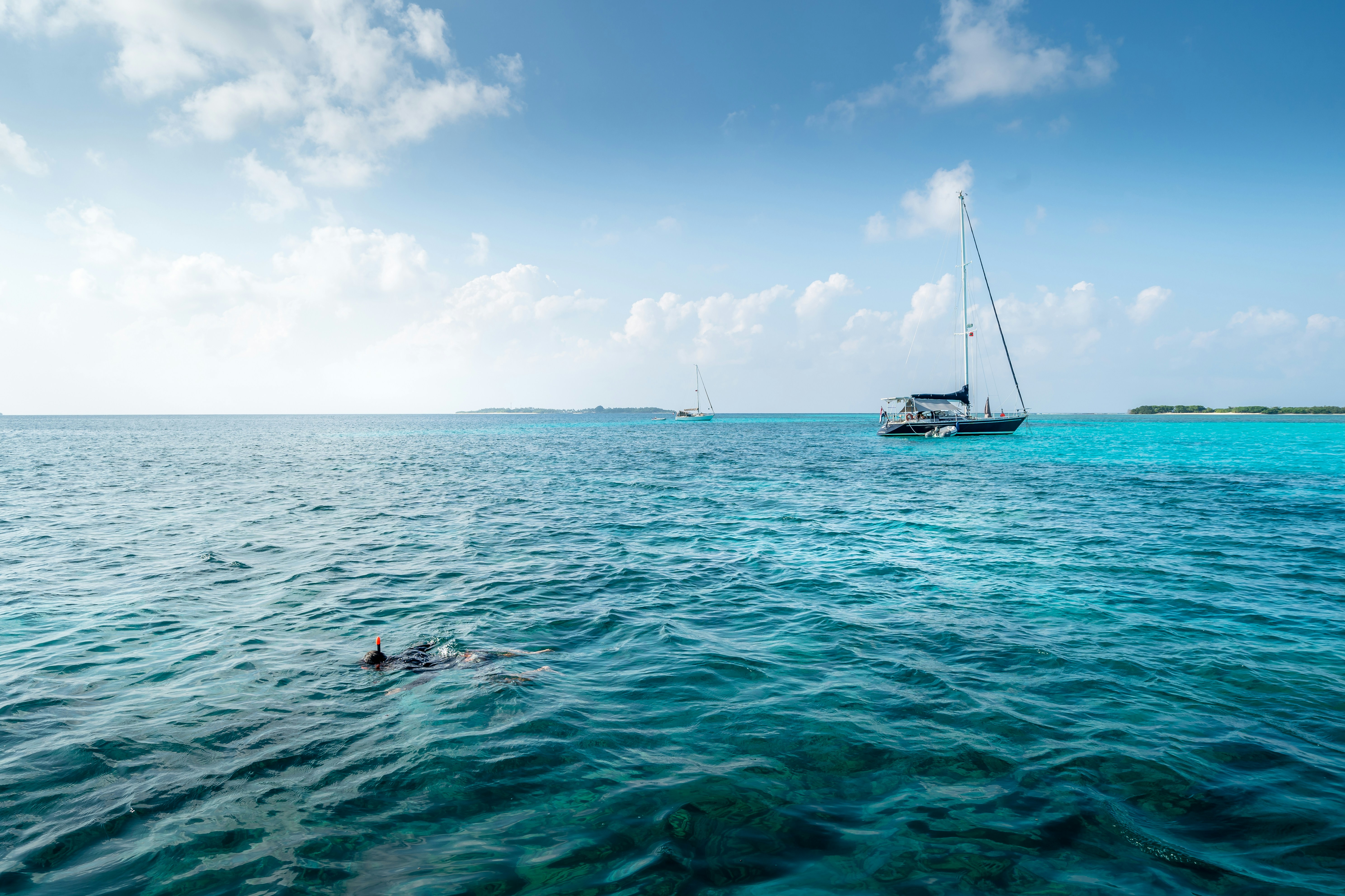 Sailboat at the Horizon, Gentle Sea under a Bright Sky