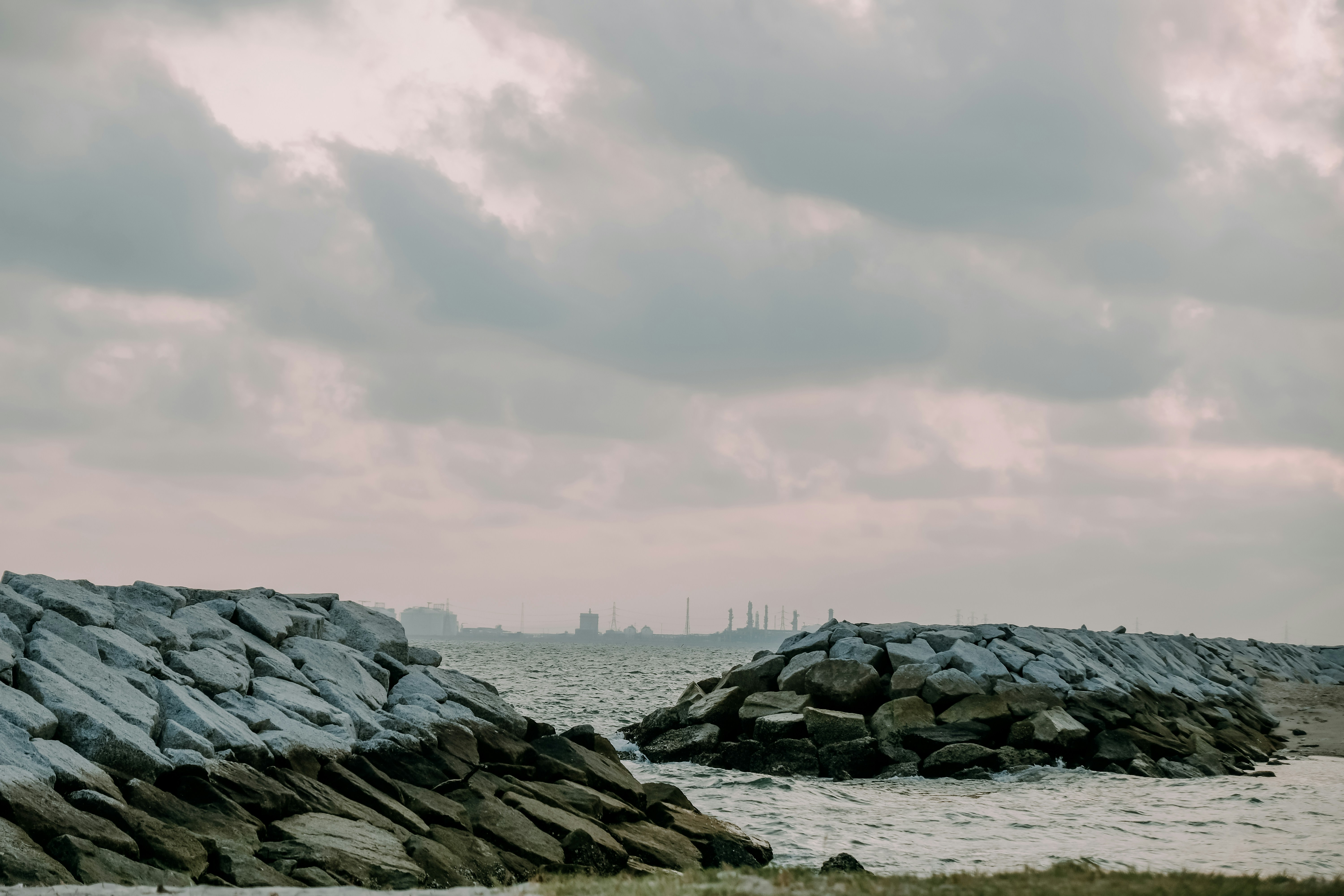 Rugged breakwaters under a brooding afternoon