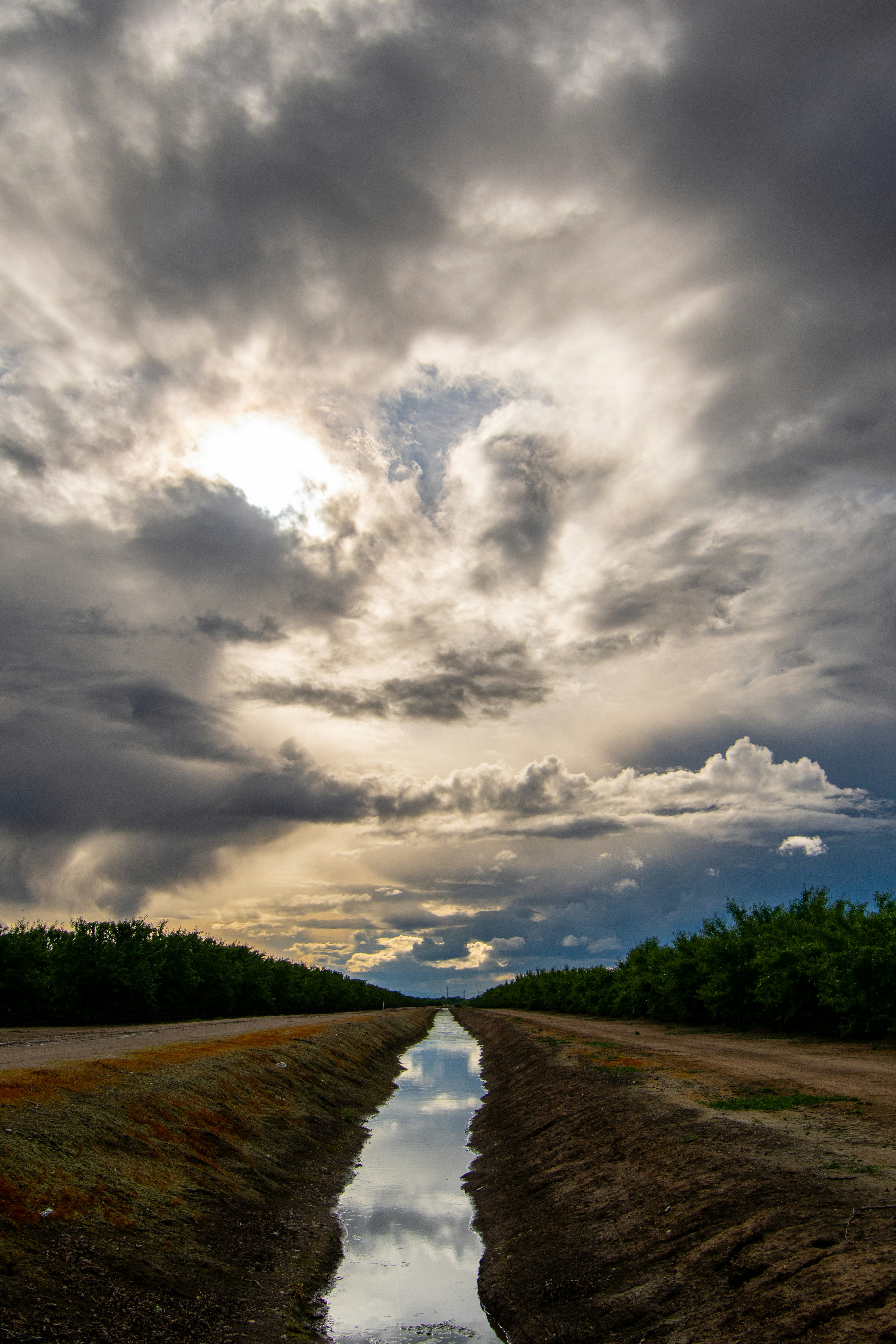 Skyward Canal: A Narrow Waterway Cuts Through a Storm-Lorn Horizon