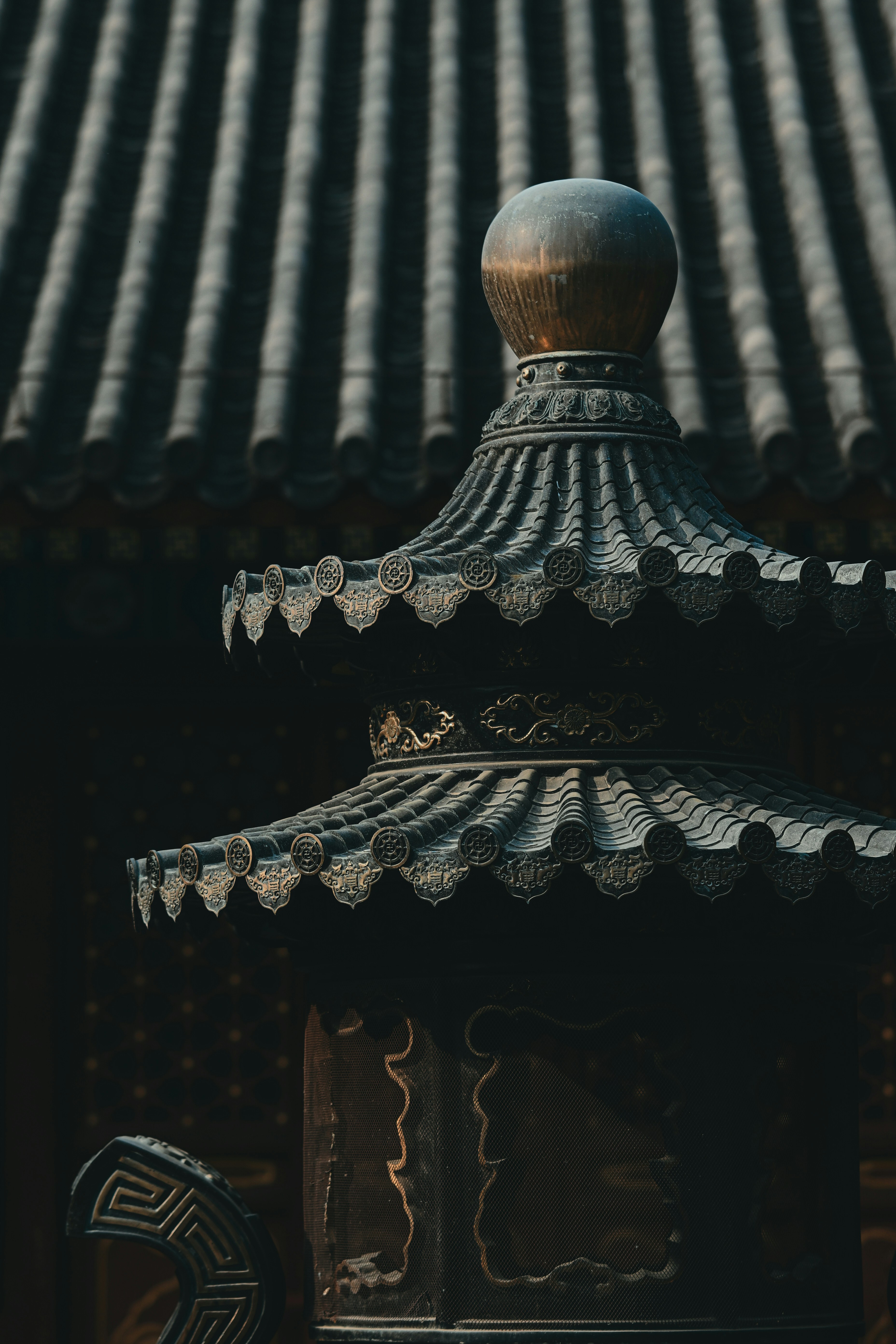 Temple Finial in Low Light: A Quiet Peak Over Quiet Tiles