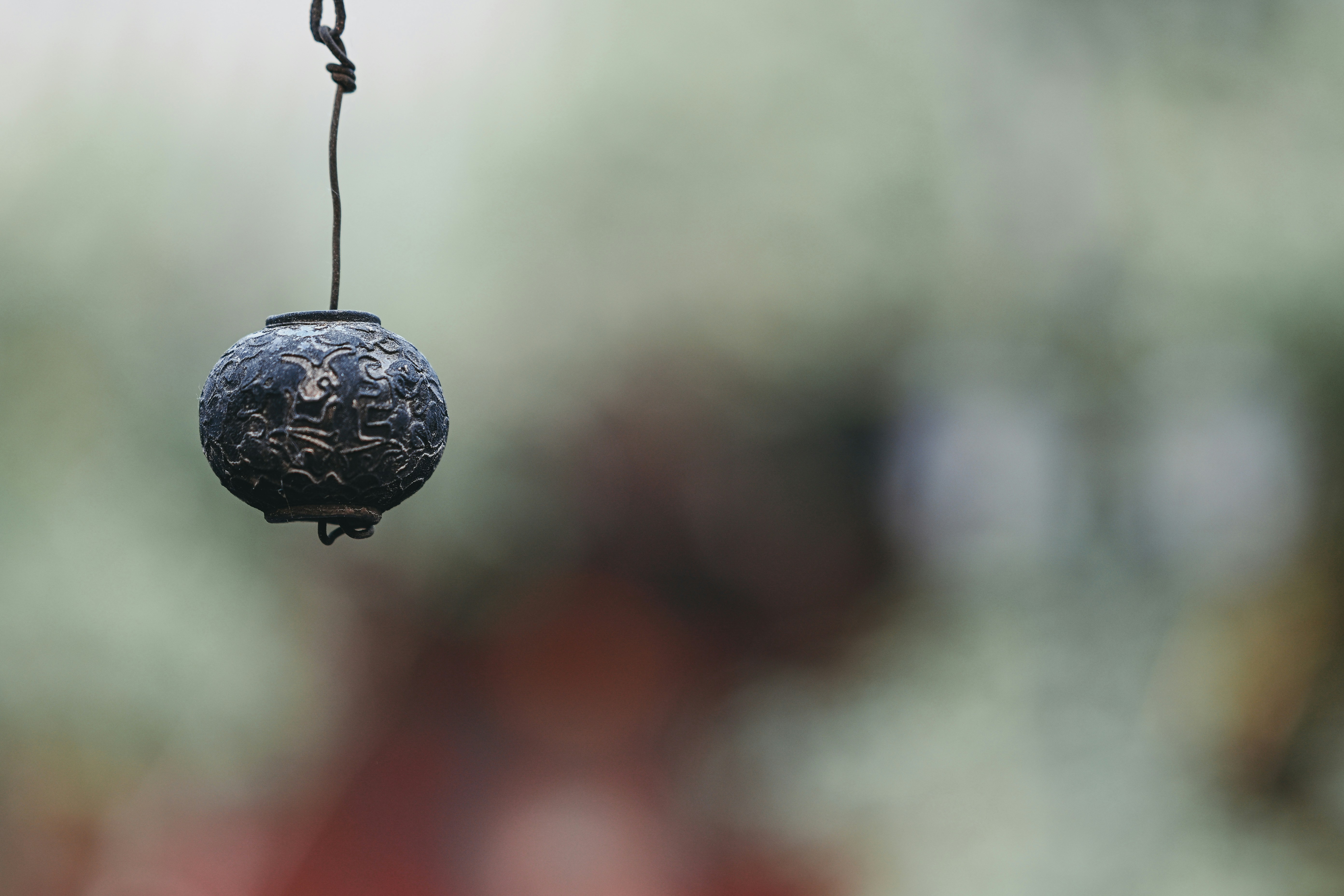 Lingering Ornament: A Hanging Carved Sphere in Soft Focus