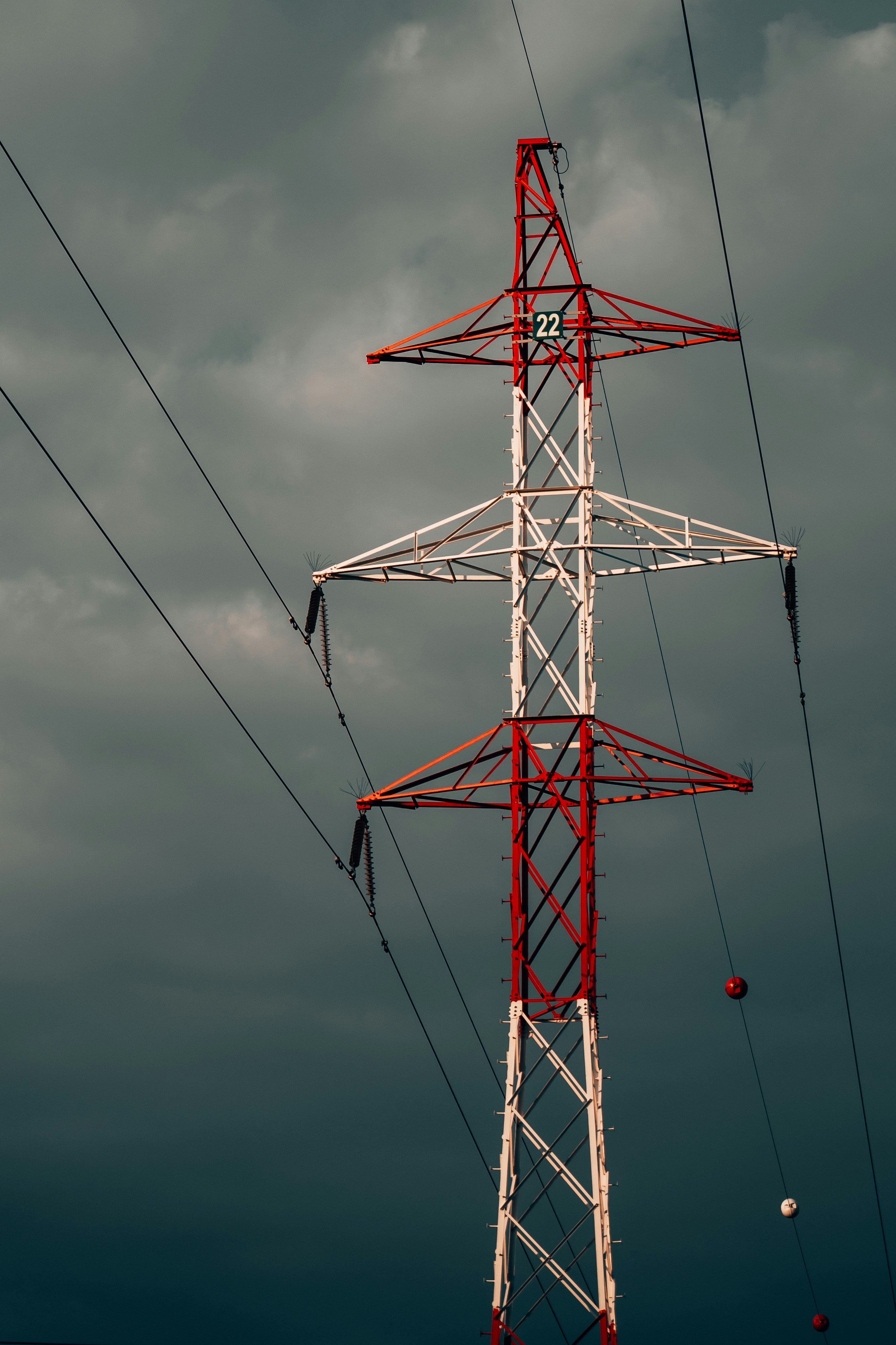 Crimson-Topped Transmission Tower Piercing A Dark Sky