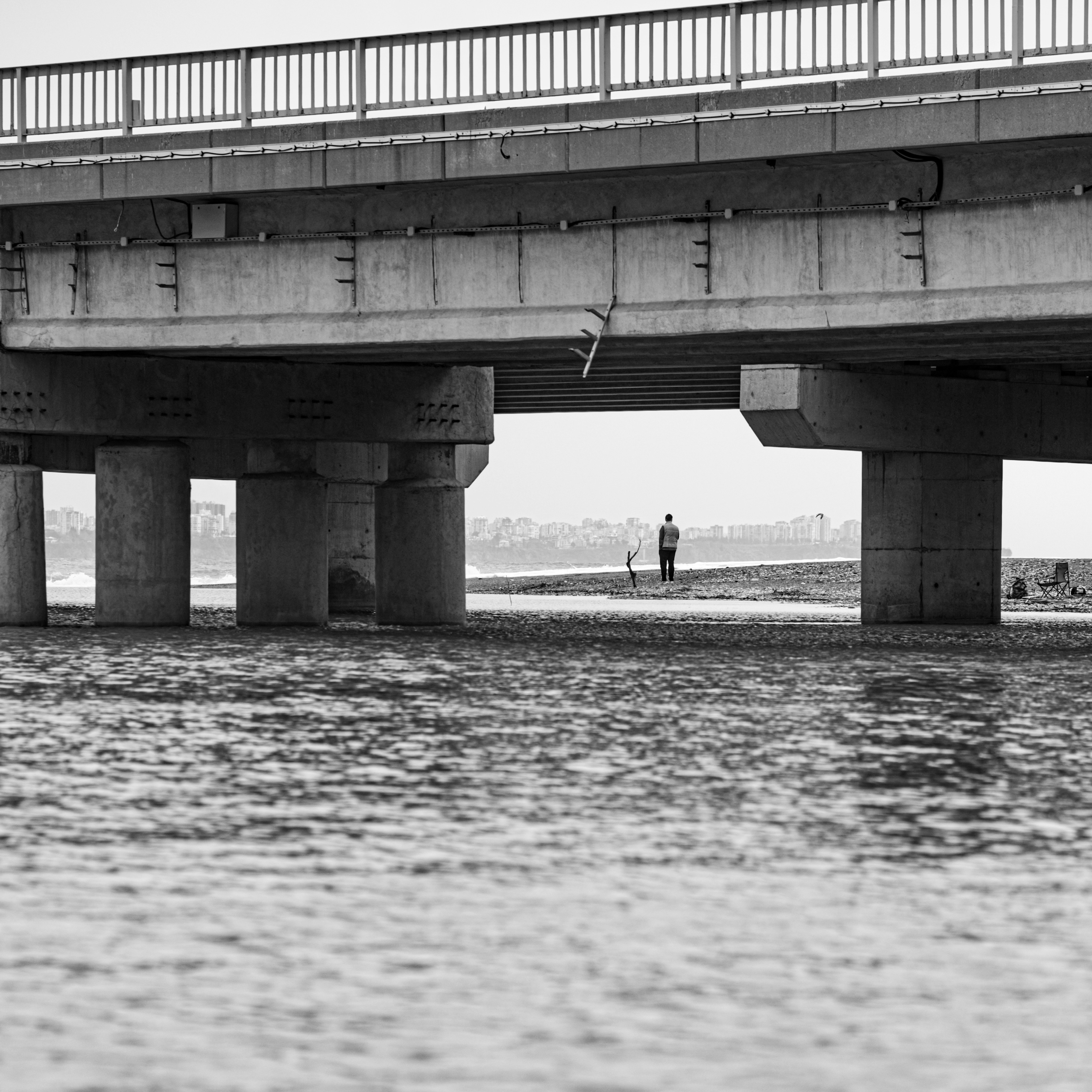 Under the Span: A Lone Angler under the Bridge
