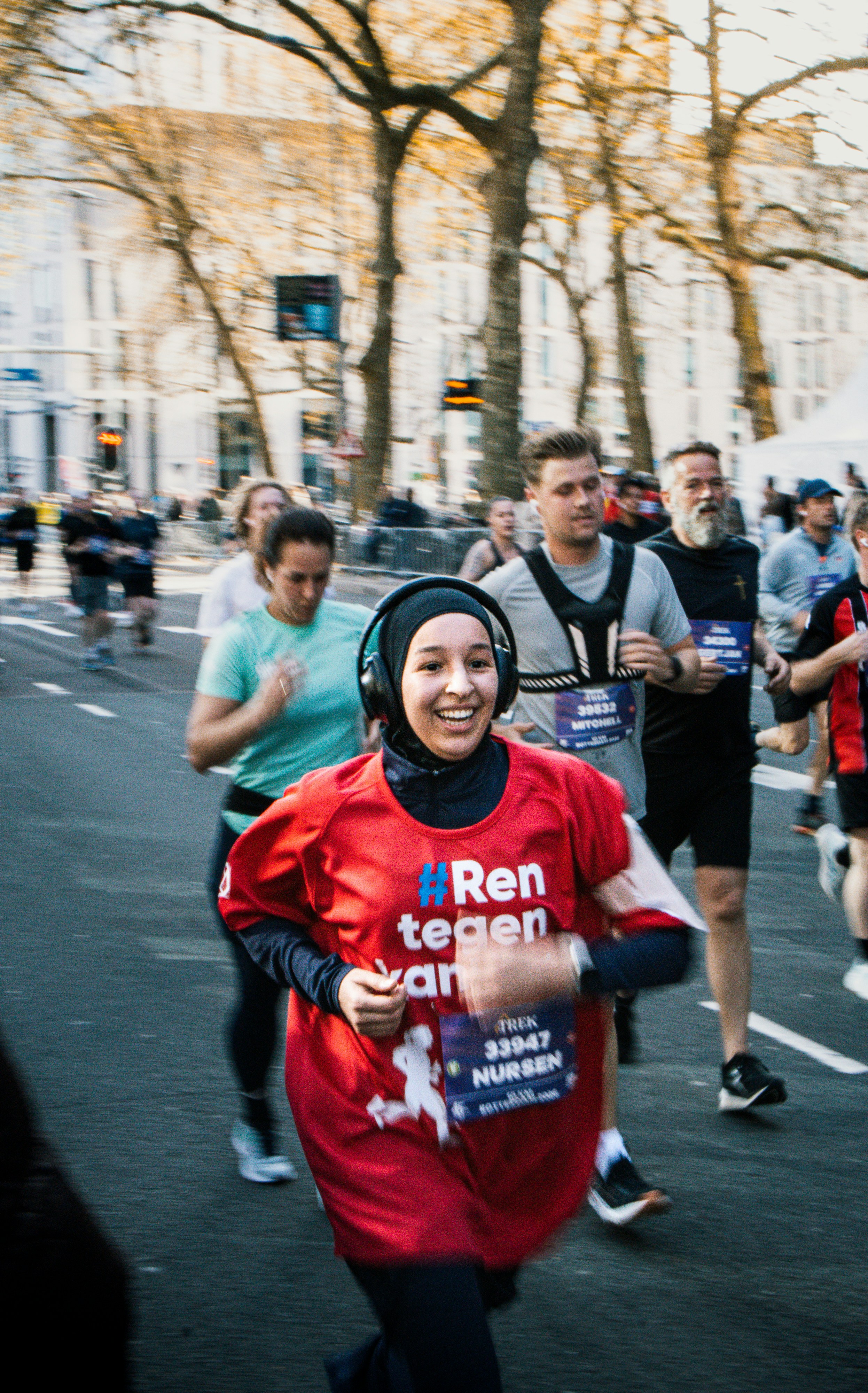 Runner in Red Jersey Leads a City Marathon Crowd
