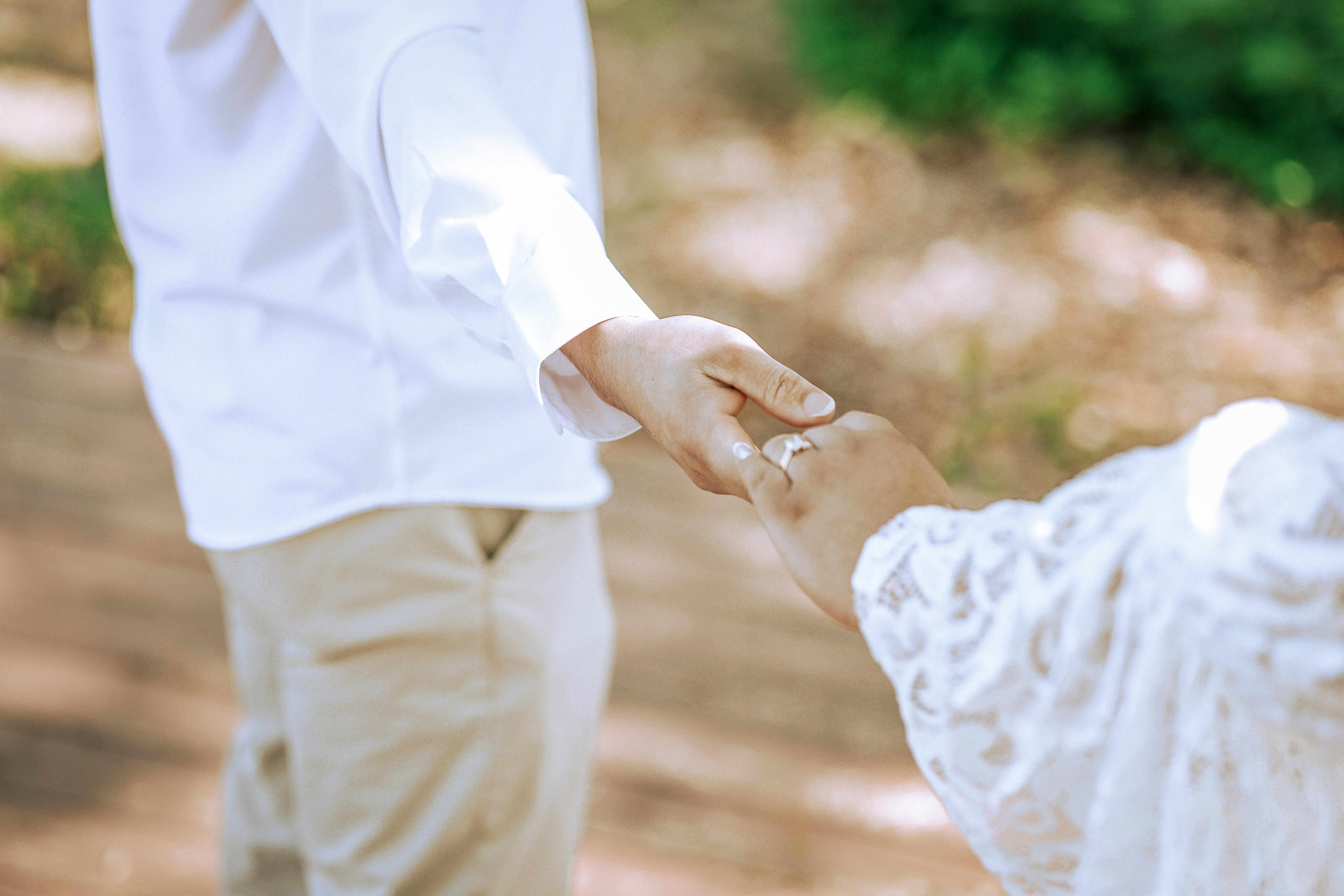 A Gentle Exchange: Hands Joining in a Quiet Outdoor Moment