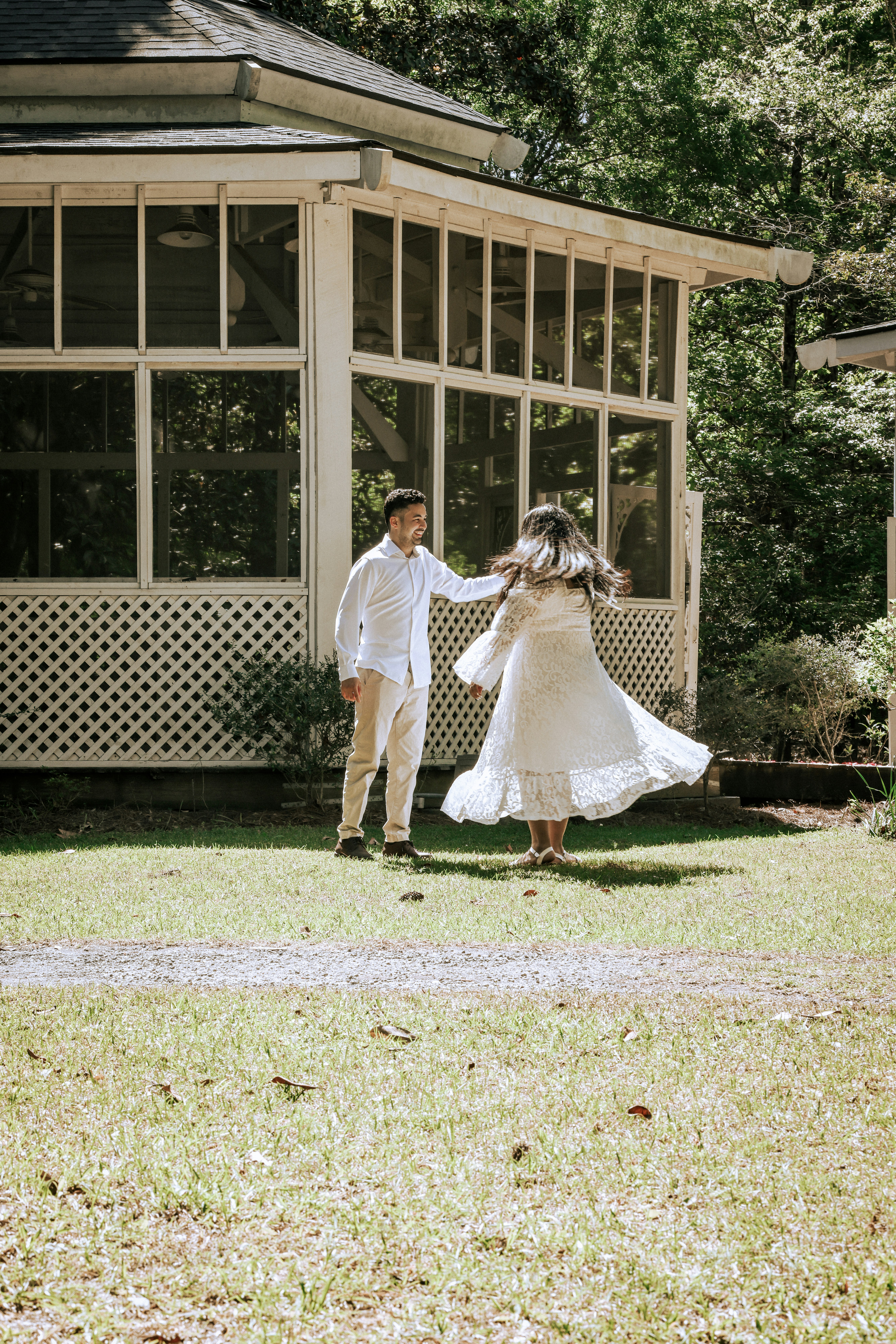 Whirl of White: A Bride and Groom in a Sunlit Garden Moment