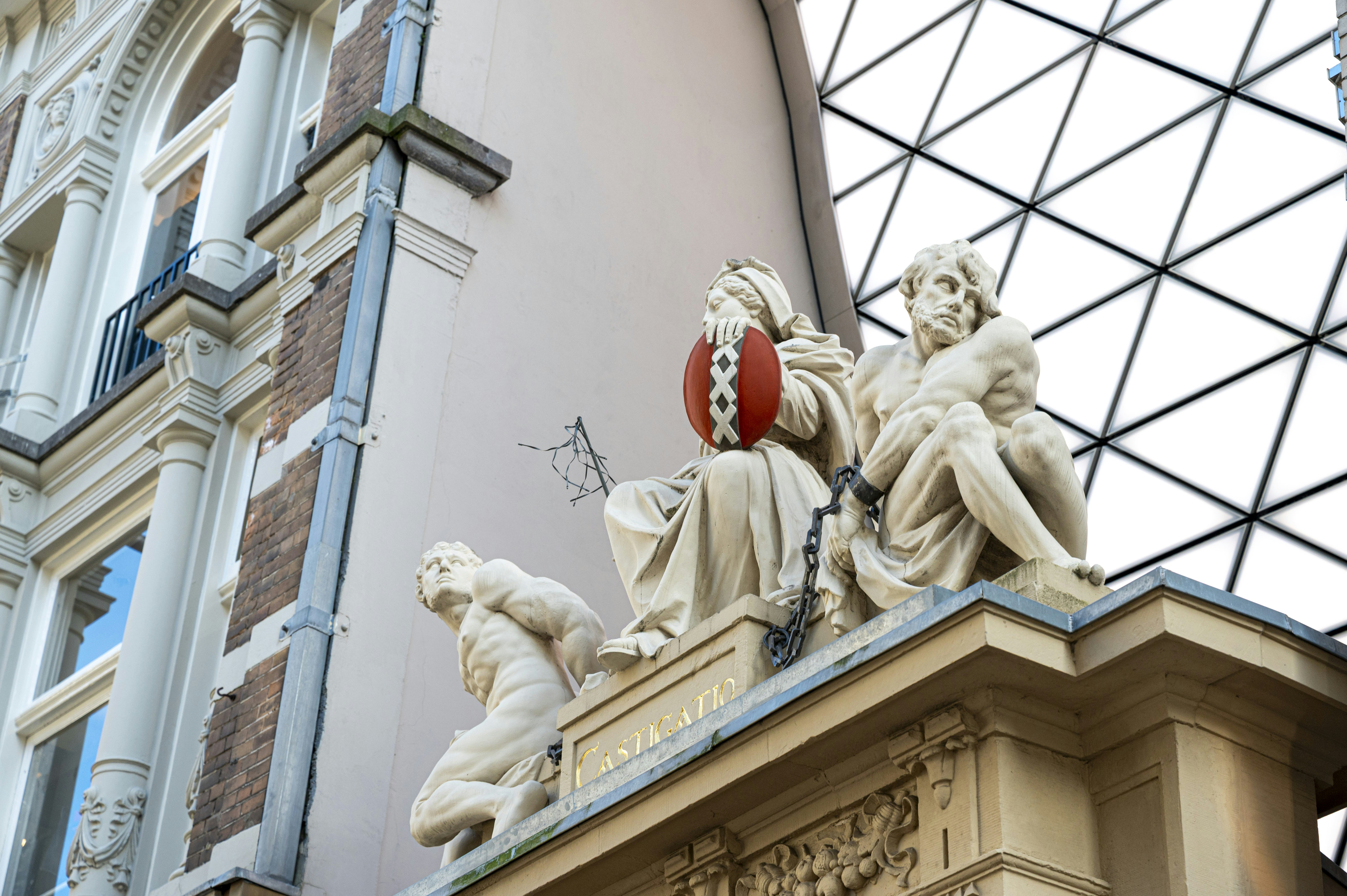 Statue Ensemble in a Modern Glass Roof Framing