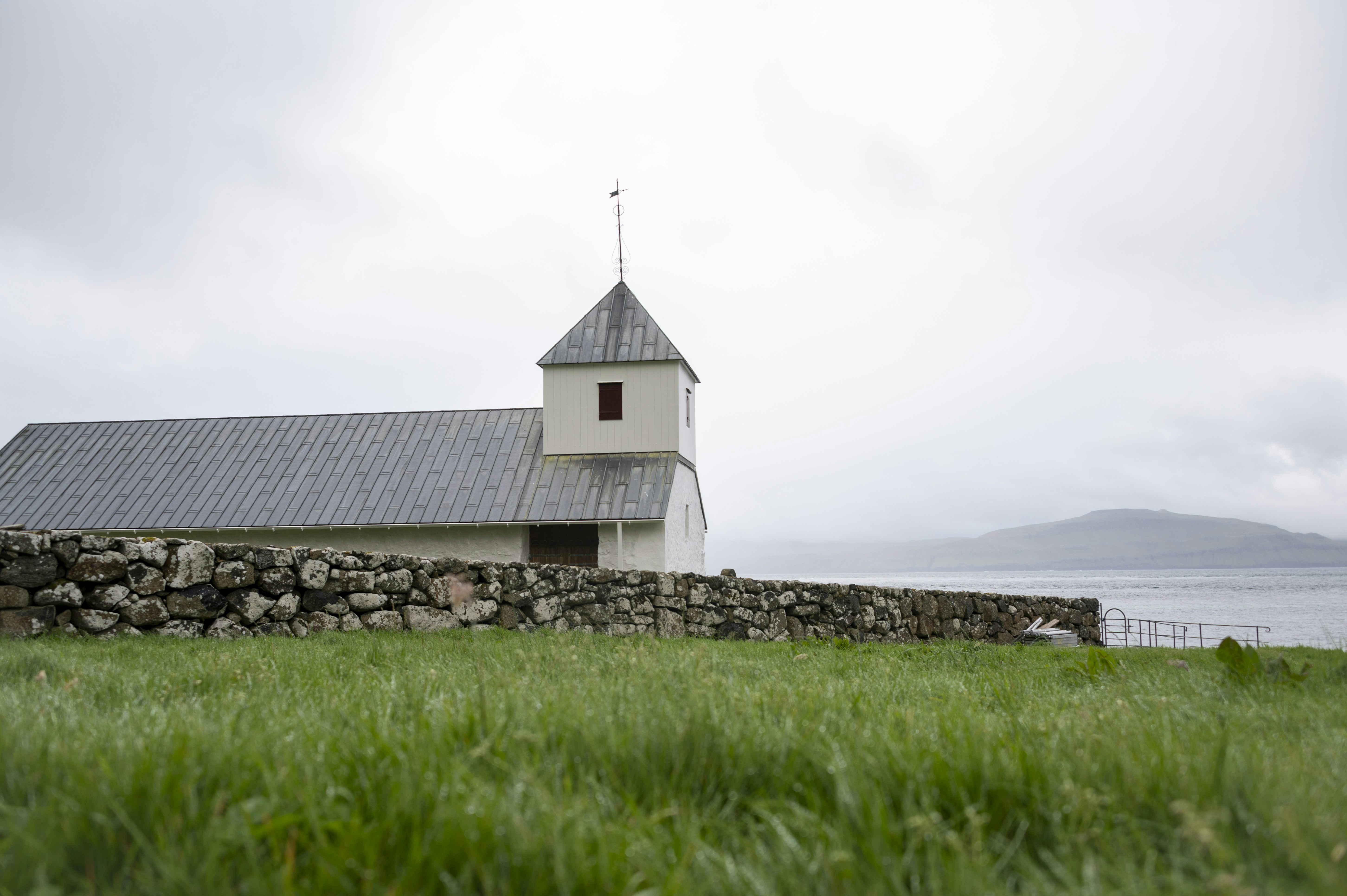 Coastal Outpost: A Stone Wall Framing a Quiet Chapel
