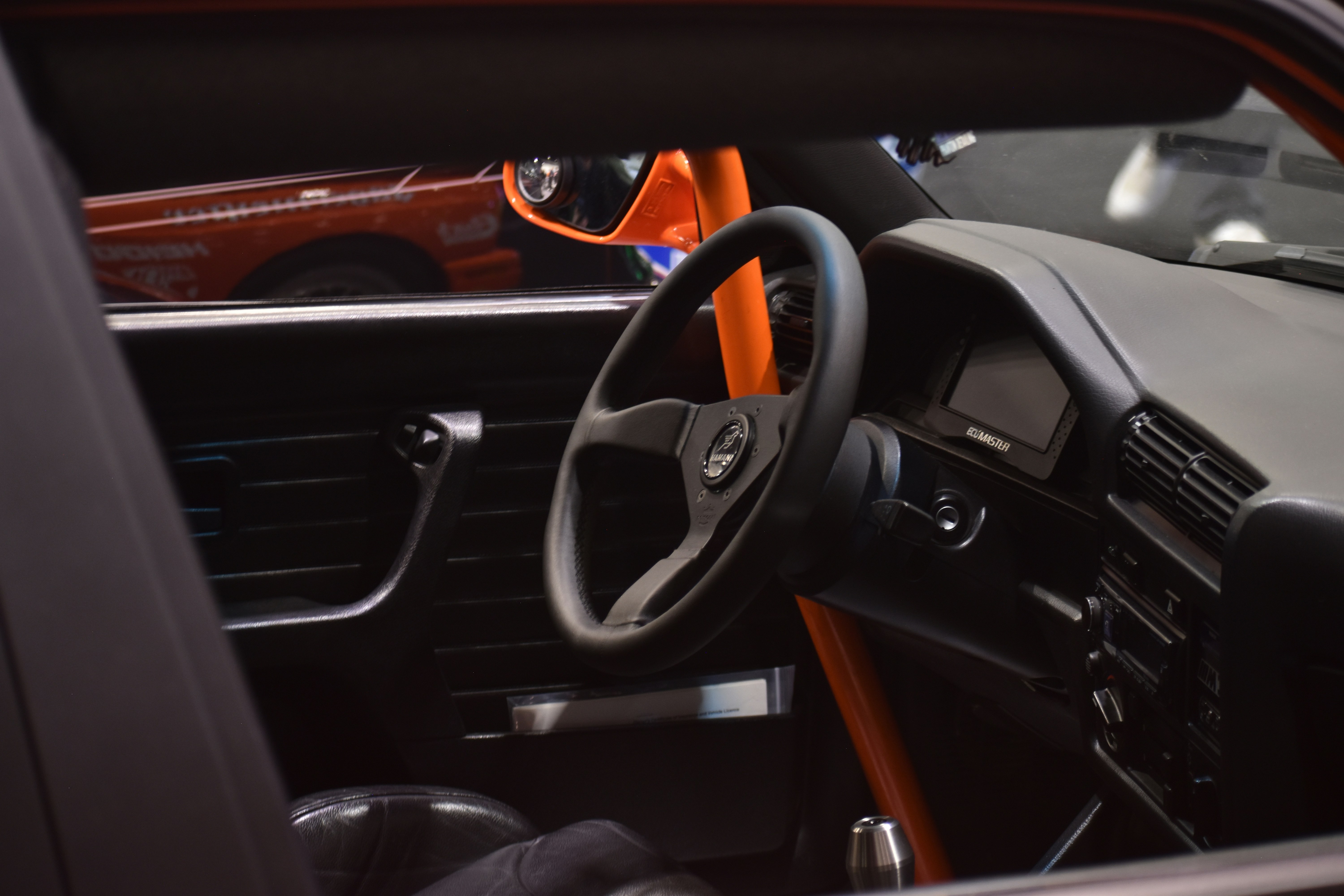Cockpit of Color: An Orange Roll Cage Behind the Wheel