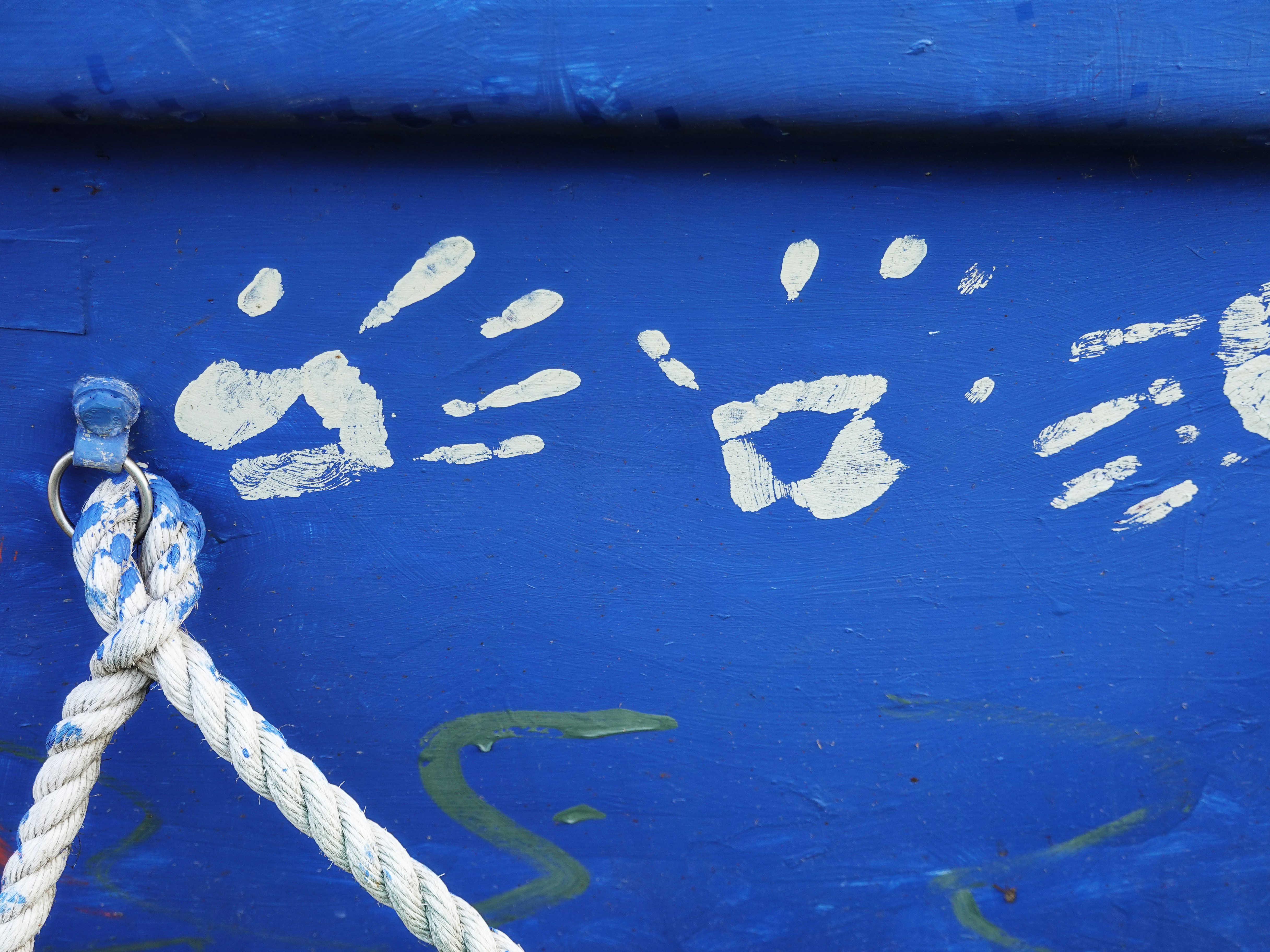 Blue Hull with White Handprints and Rope Accent
