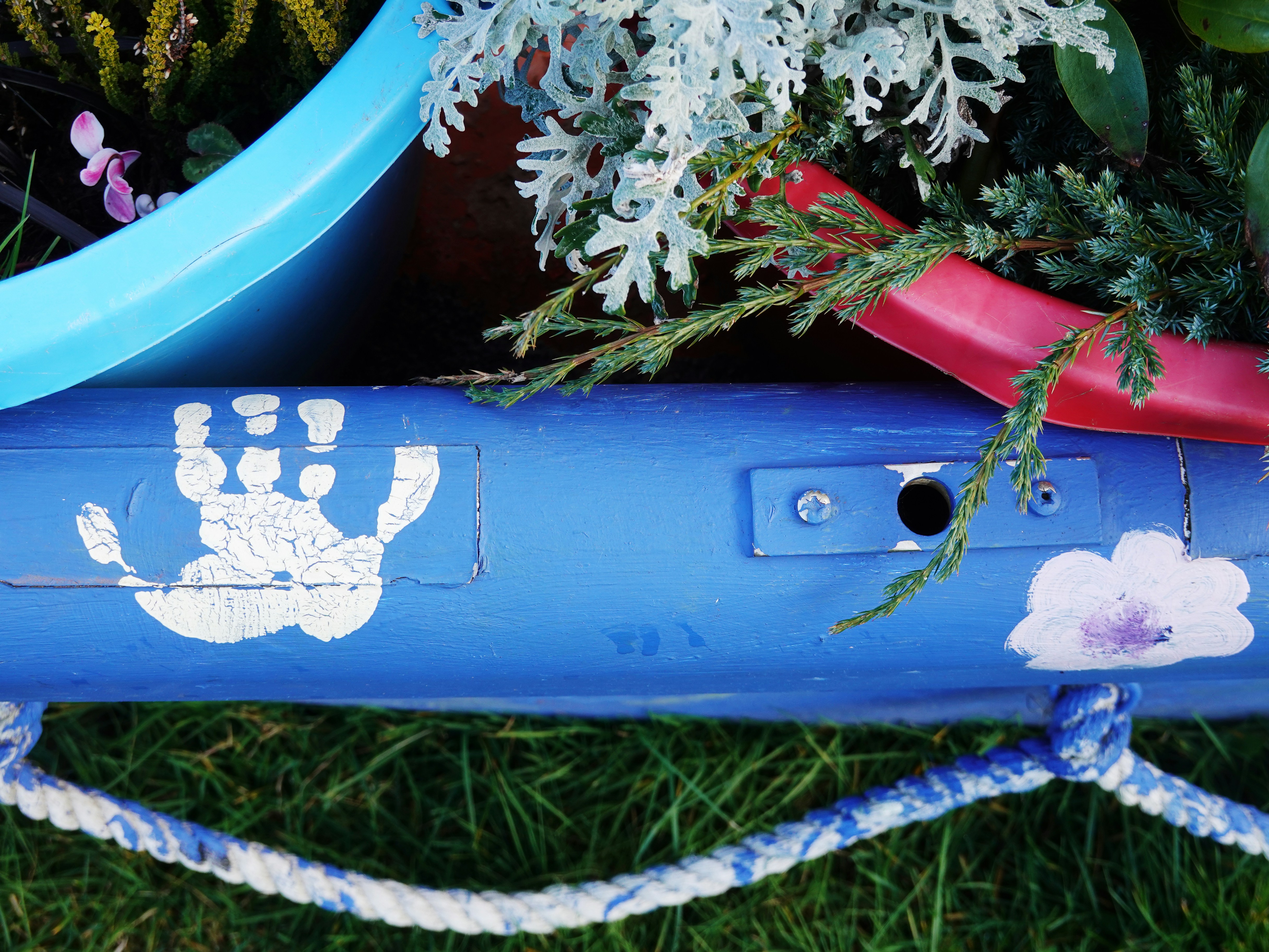 Painted Handprint on a Blue Boat with Floral Accents