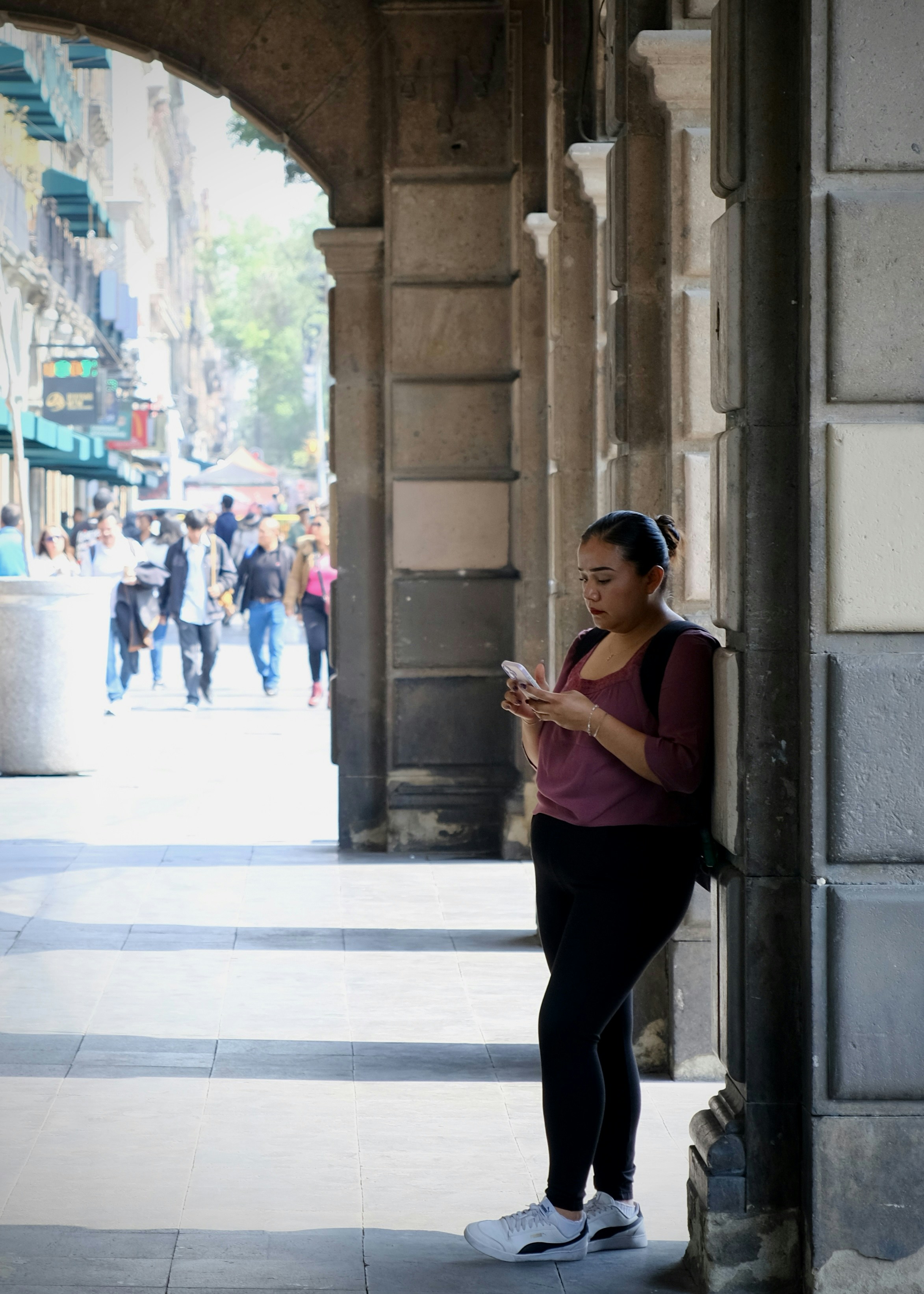 Standing Pivot: A Quiet Moment Beside the City Colonnade