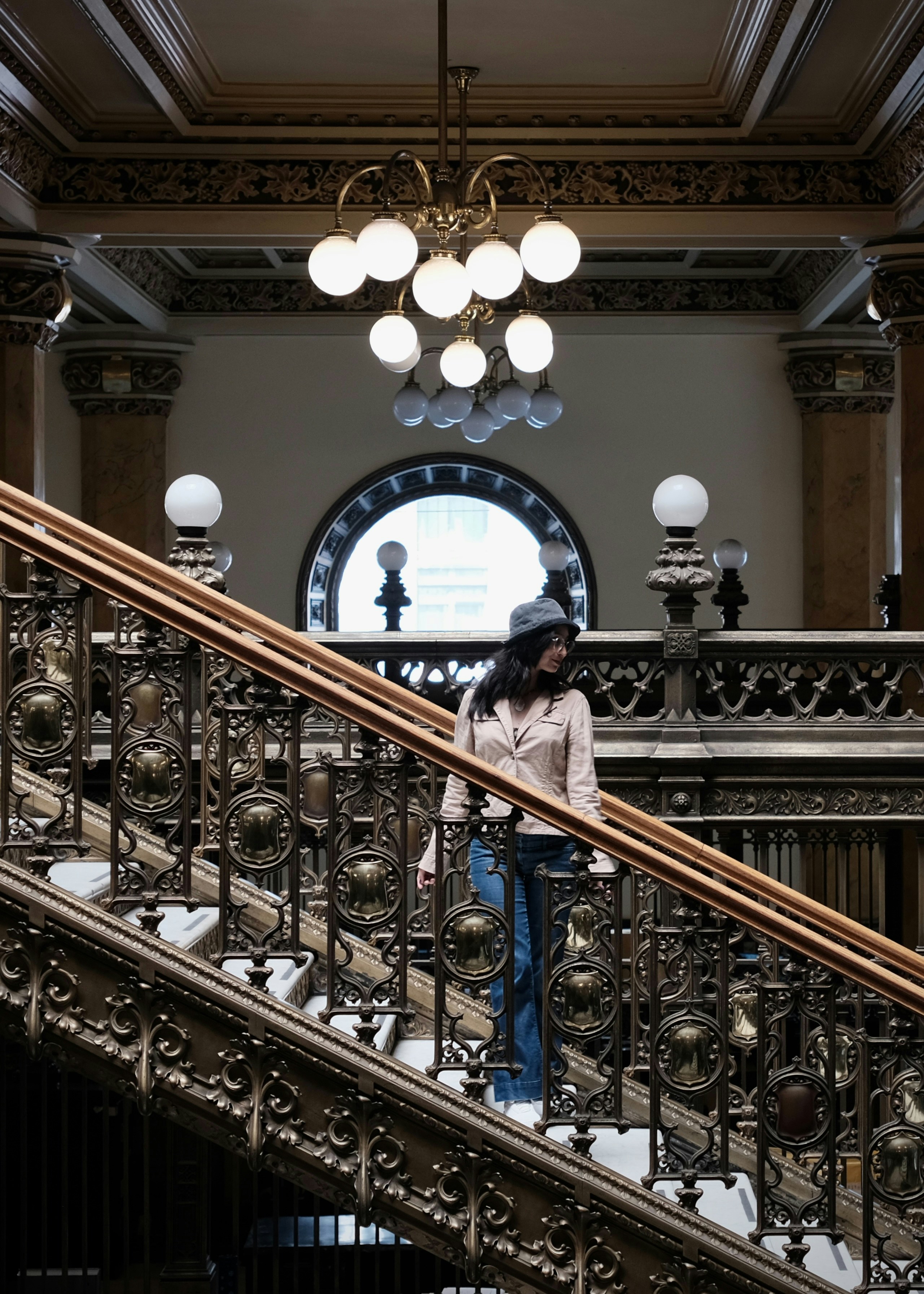 Intricate Staircase Portrait under Ornate Hallway Lanterns