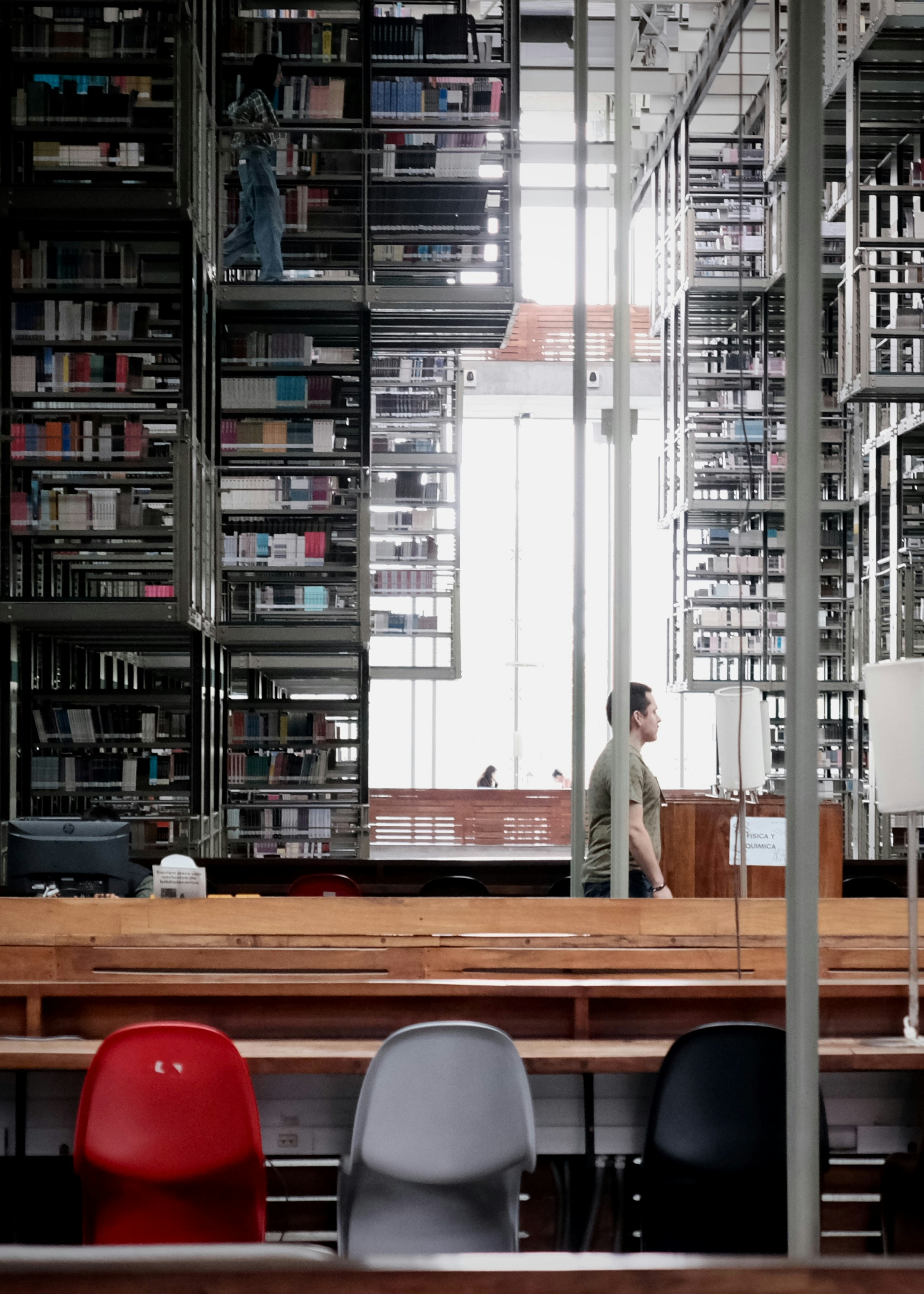 Quiet Study Corridor: A Reader's Island Among Stacked Shelves