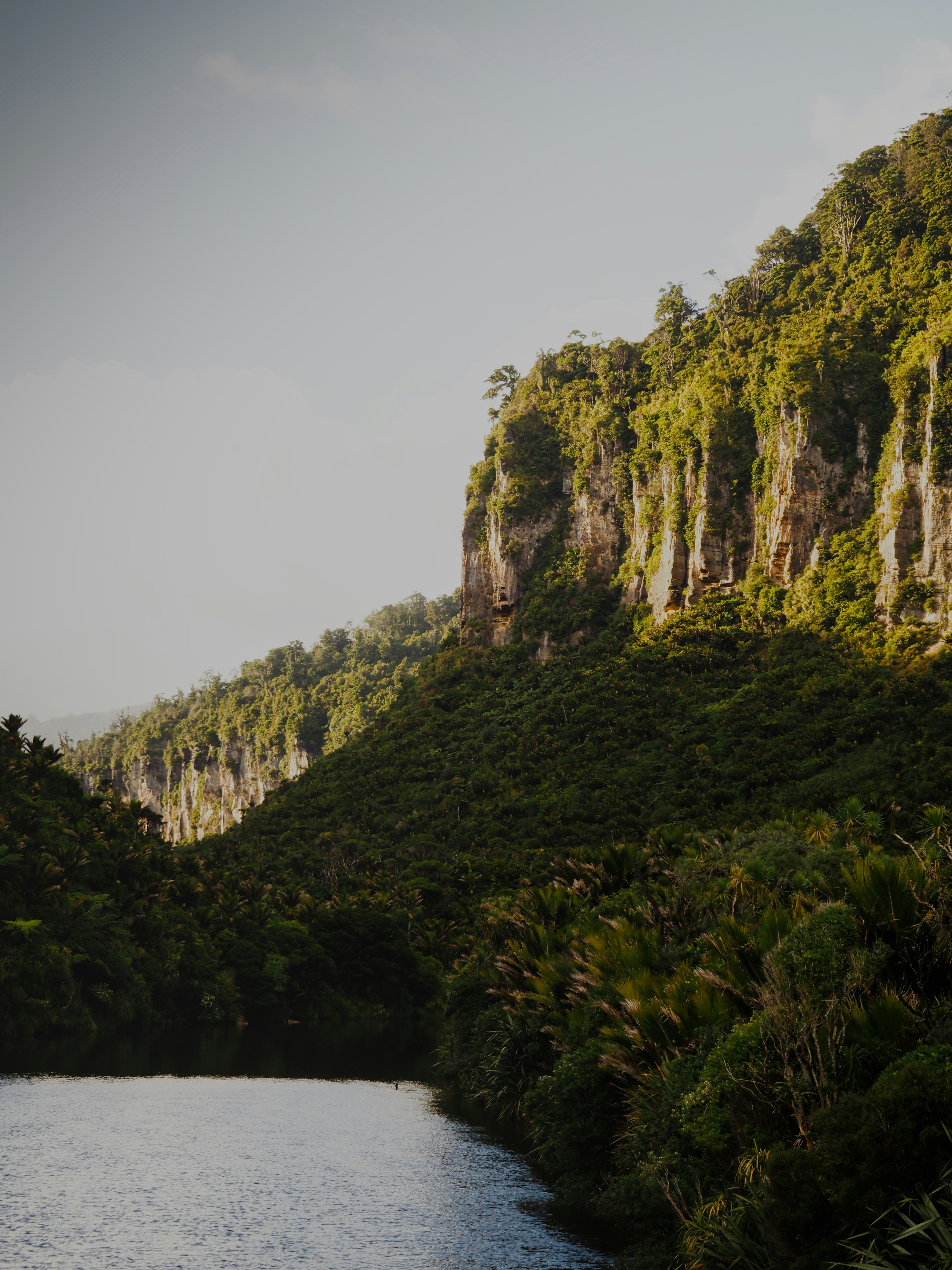 Sunlit Cliffs Over a Quiet Riverbend
