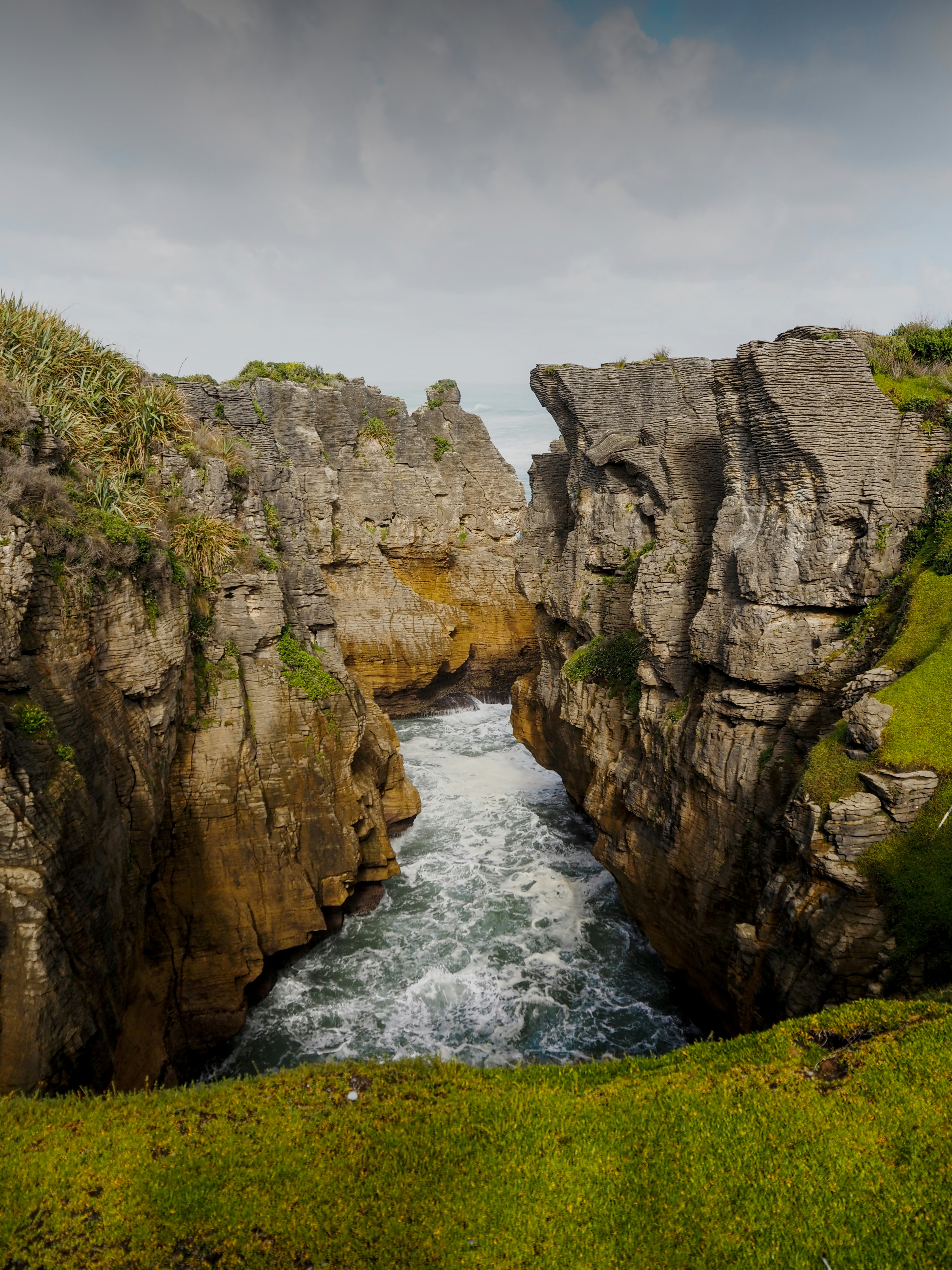 Glimmering Gorge: Tumbling Sea Through Stone Slits