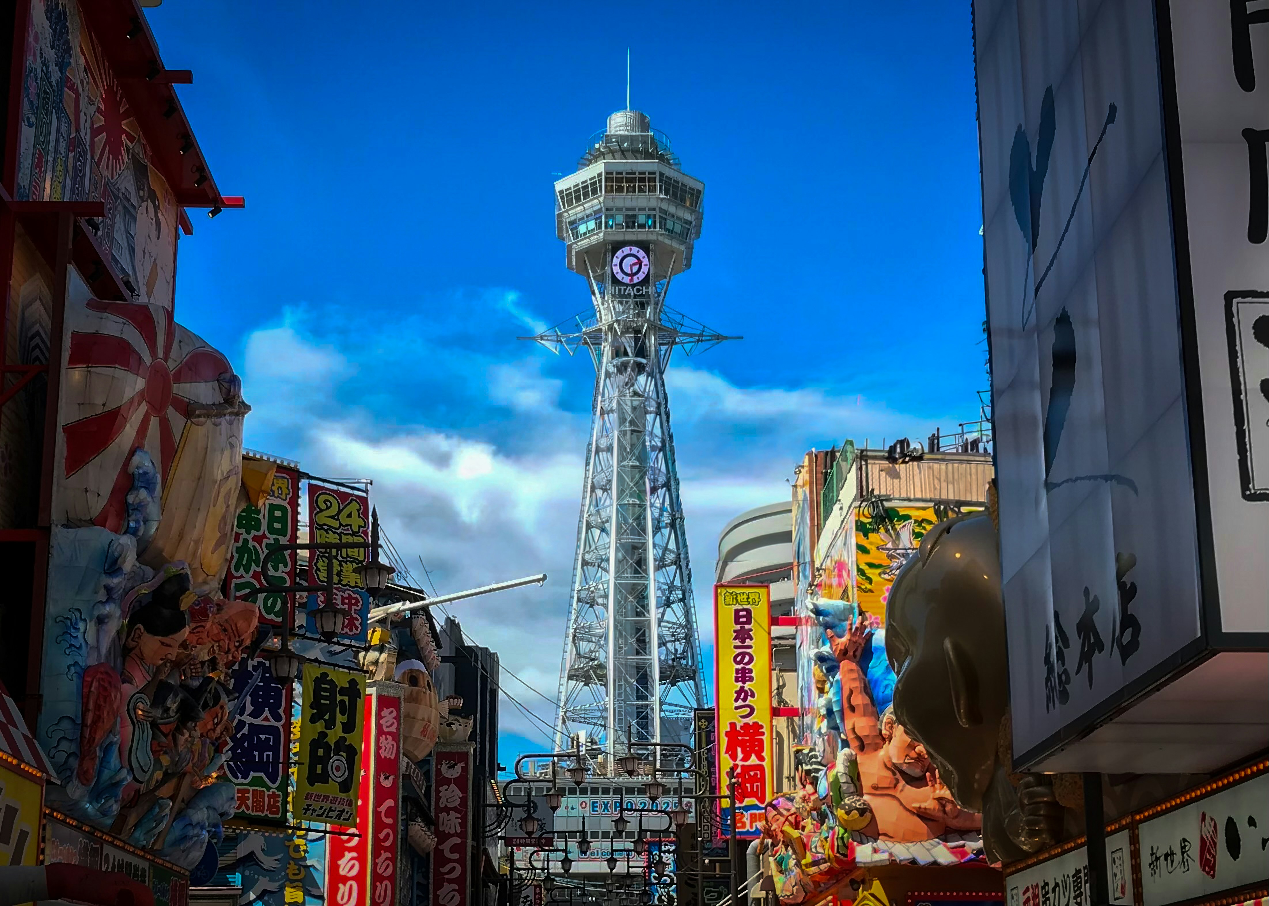 Towering Neon Pulse: The City Gatekeeper Rising Over Dazzling Streetfronts