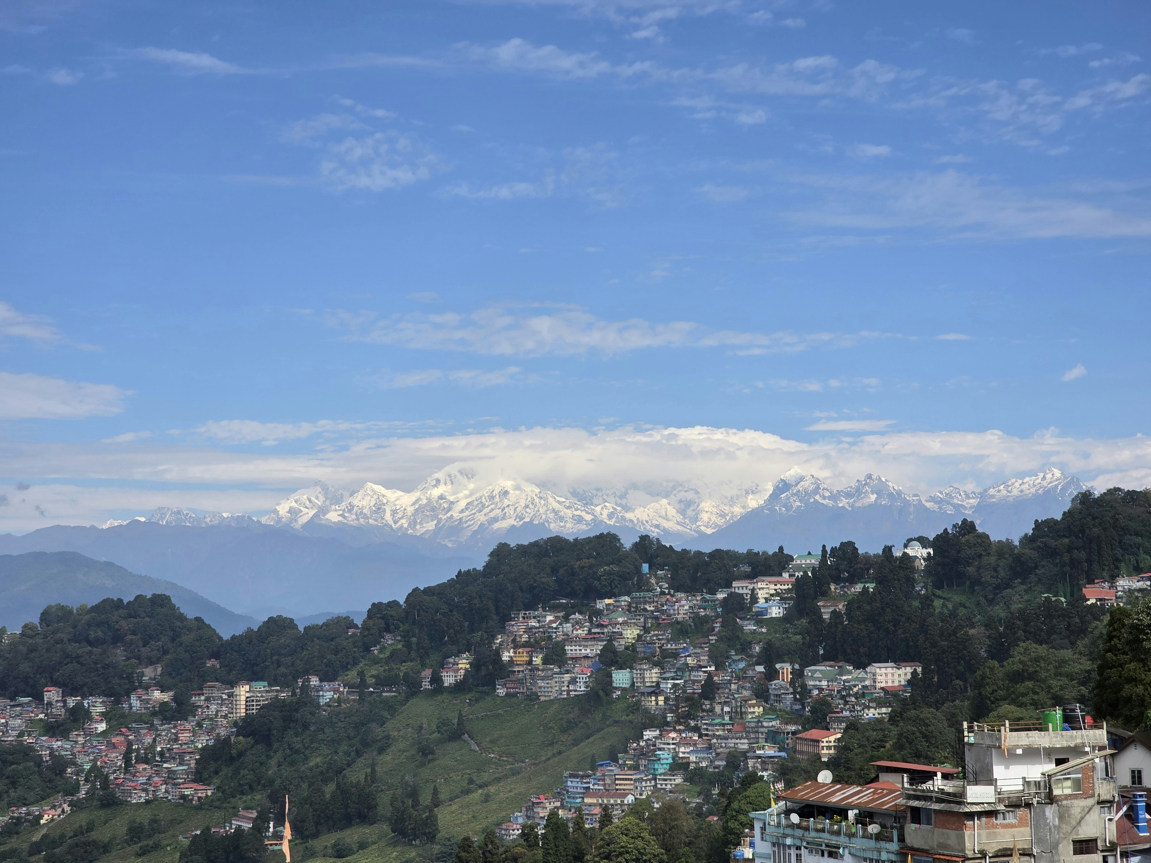 Terraced Hillside Town Framed Against Alpine Snow