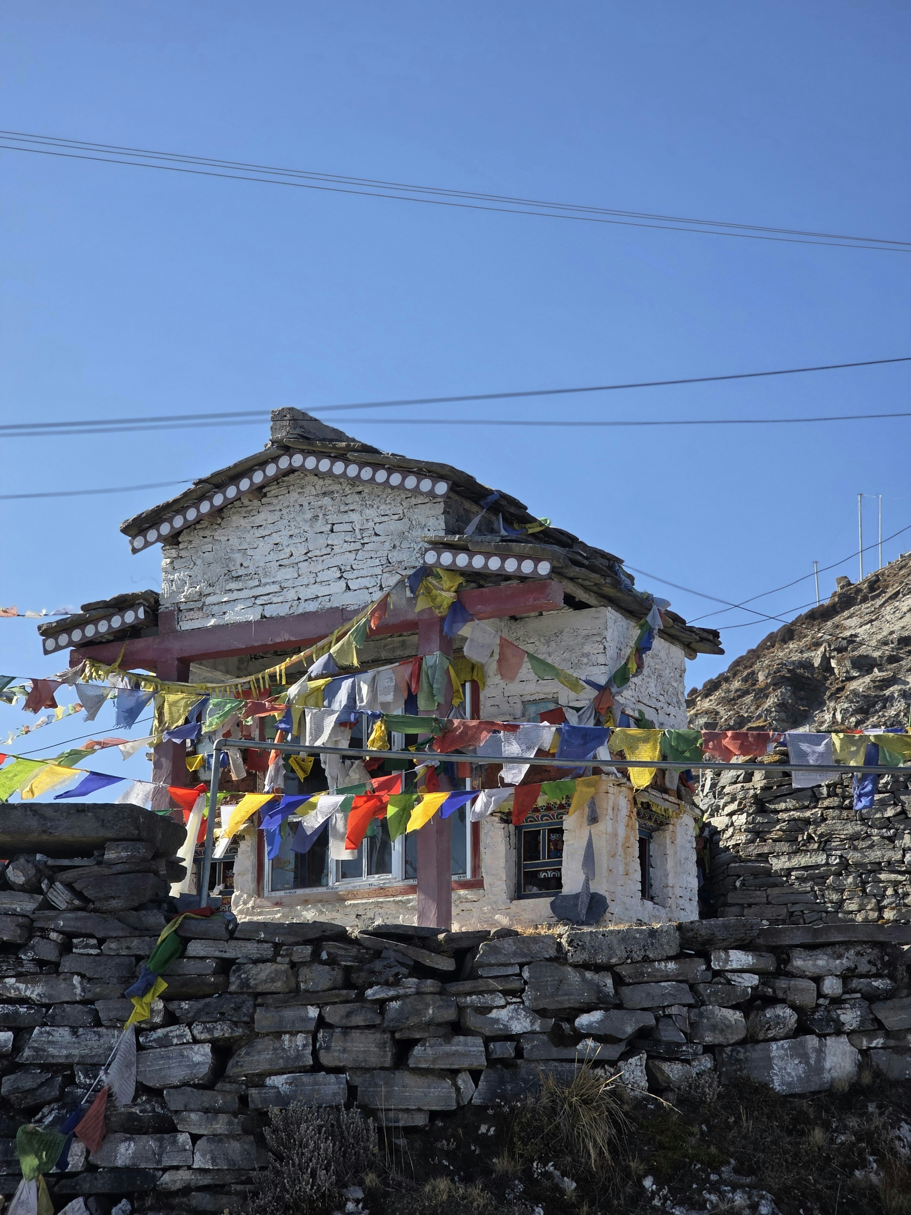 Prayer Flags and Stone Cottage in Highland Light