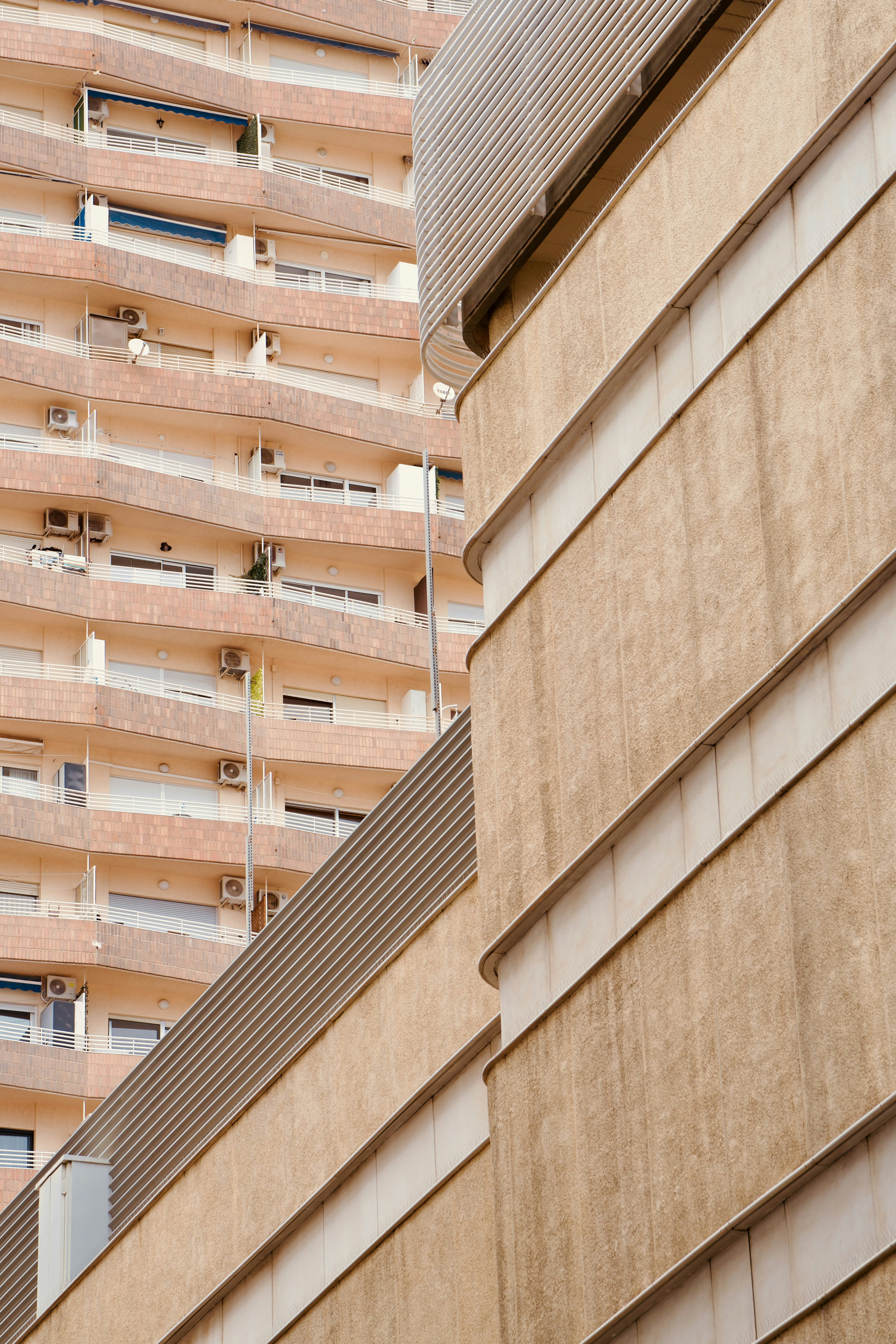 Diagonal Facades: Sunset Tones on Urban Balconies