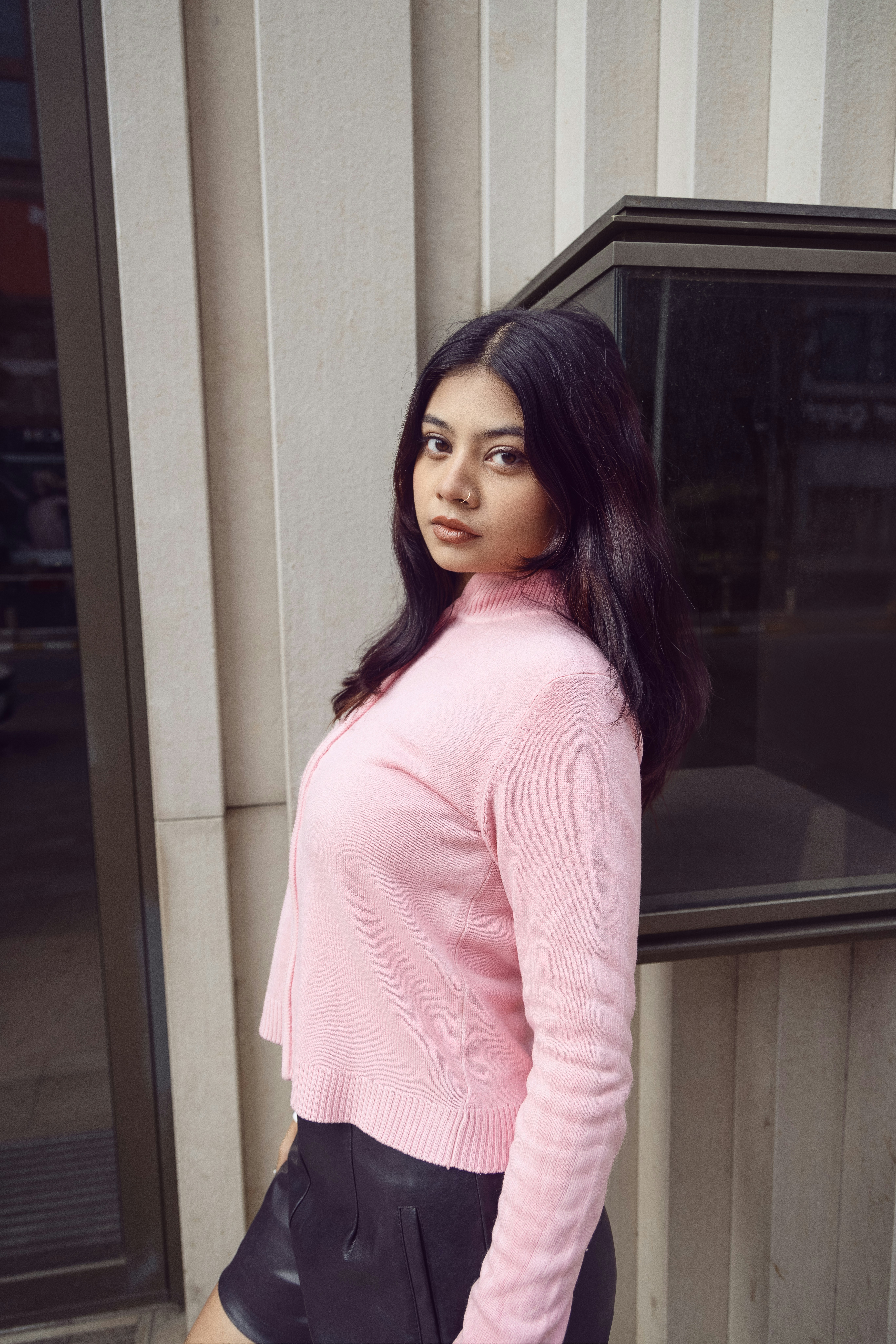 Soft Confidence in Pink: A Portrait by the Windowed Wall