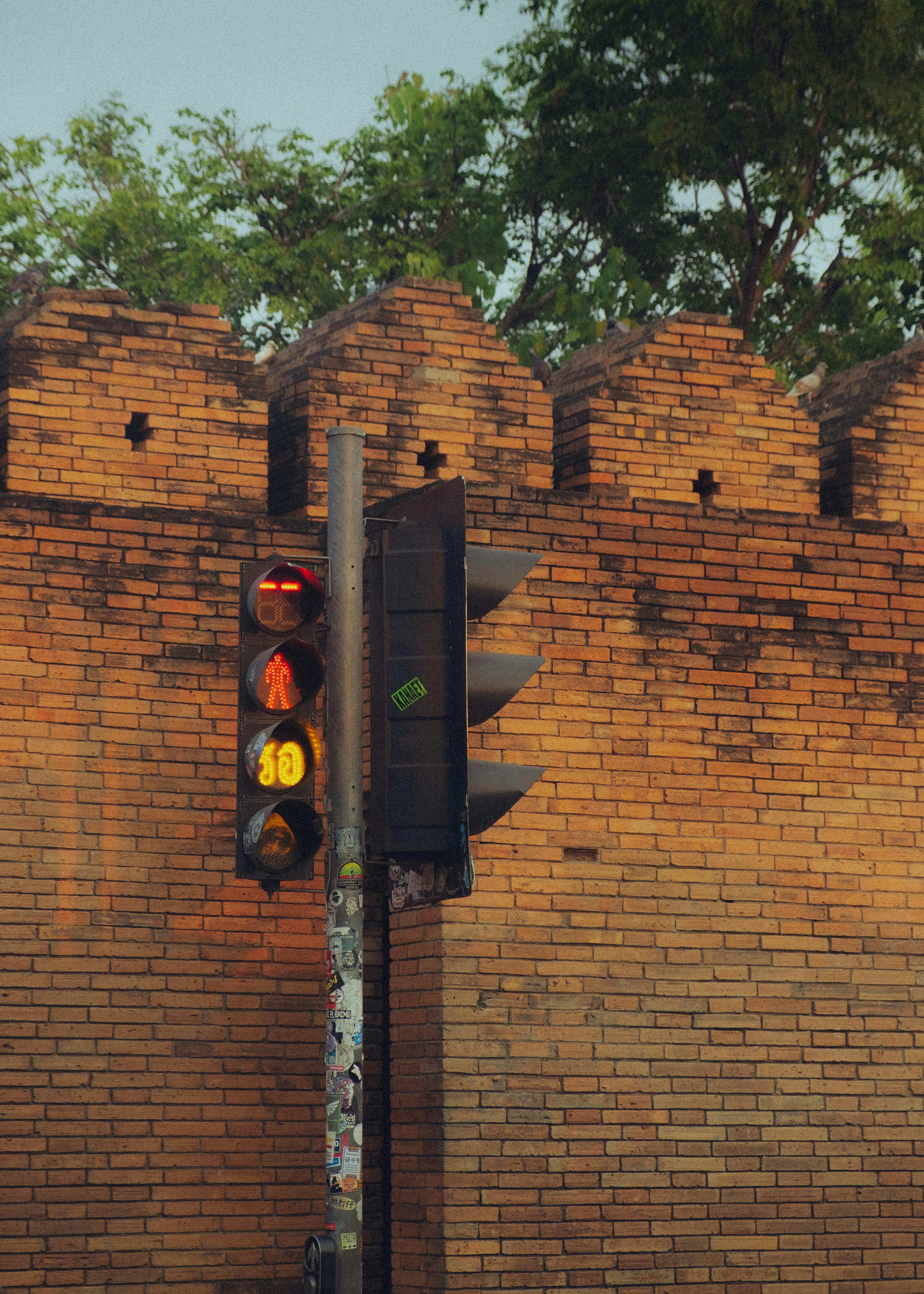 Signal in Red: A Street Corner Framed by Bricked Walls