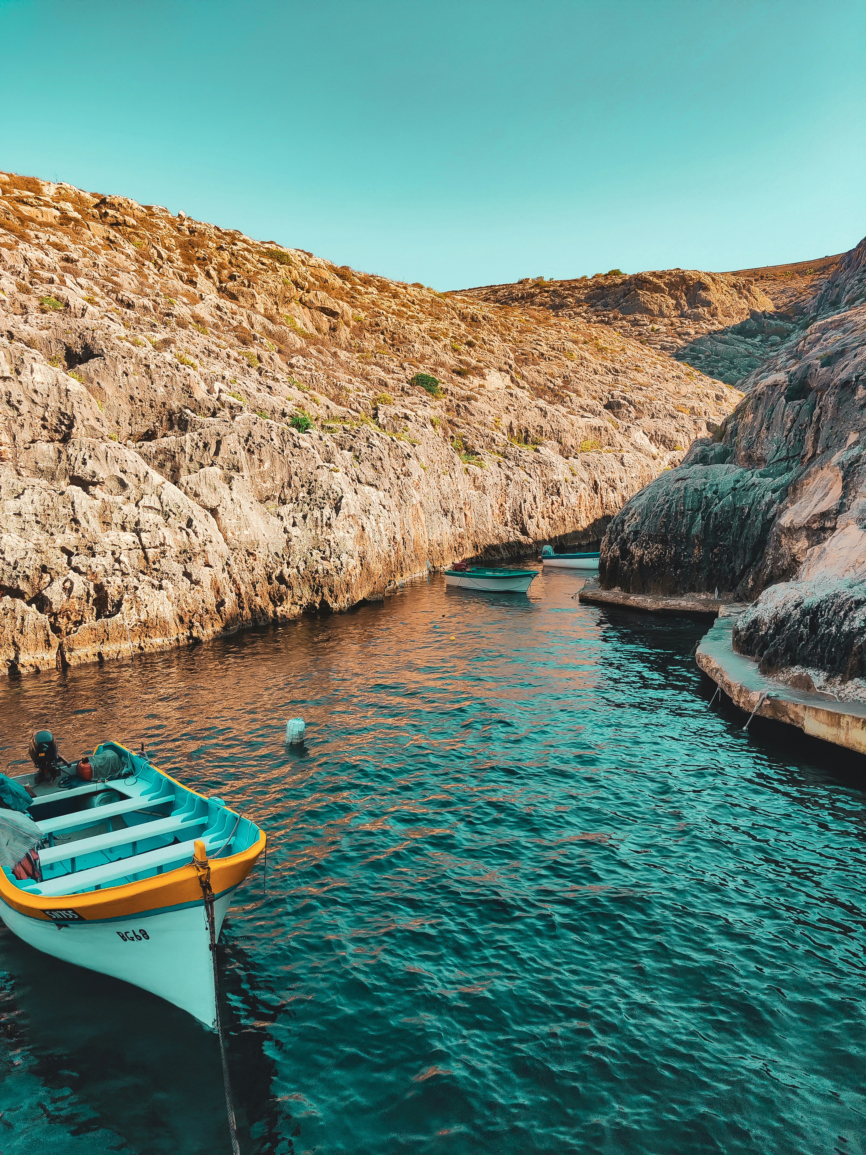 Azure Boats in a Narrow Canyon Harbor