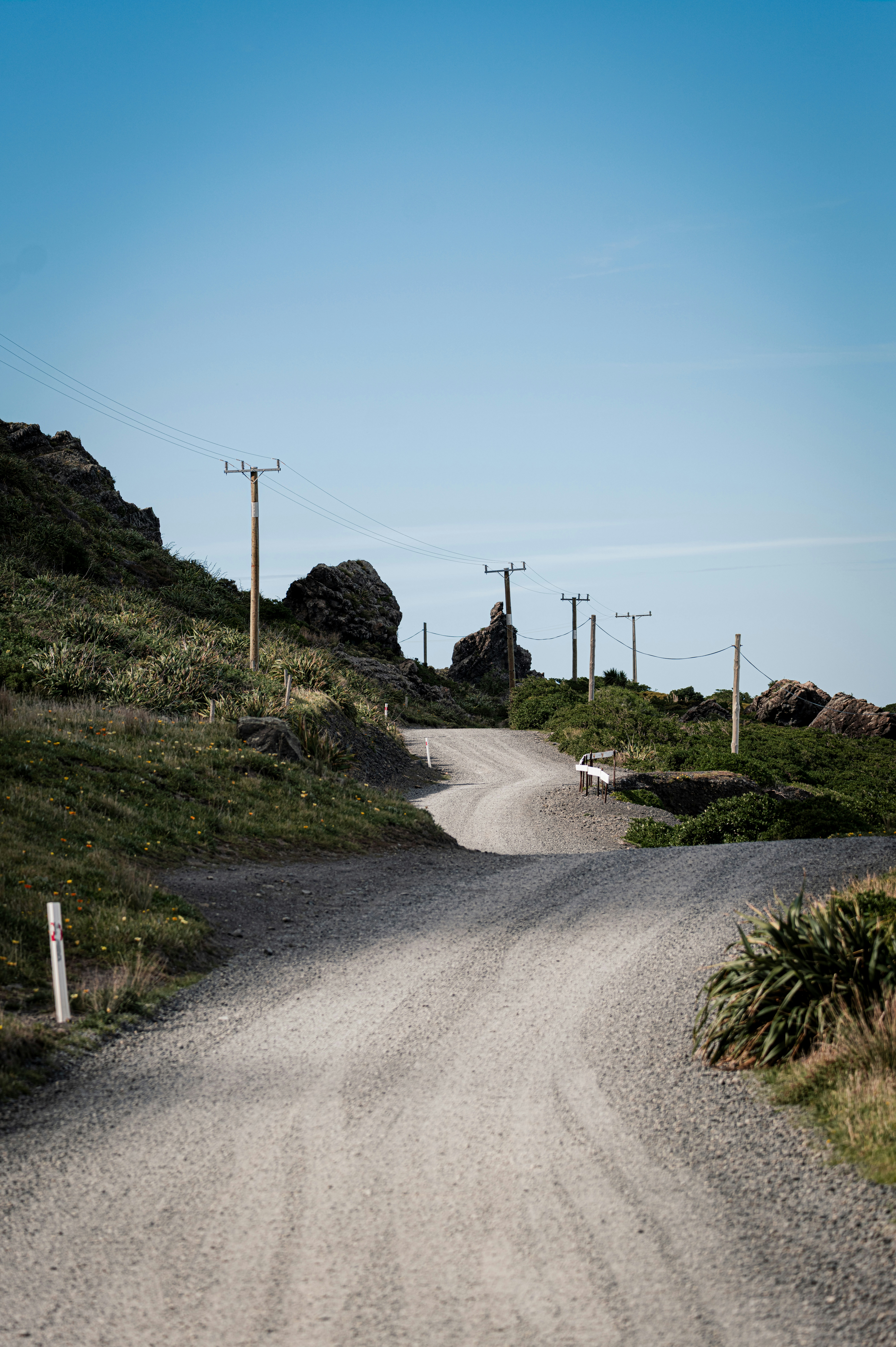 Dusty Coastal Road Tilts Toward a Quiet Horizon