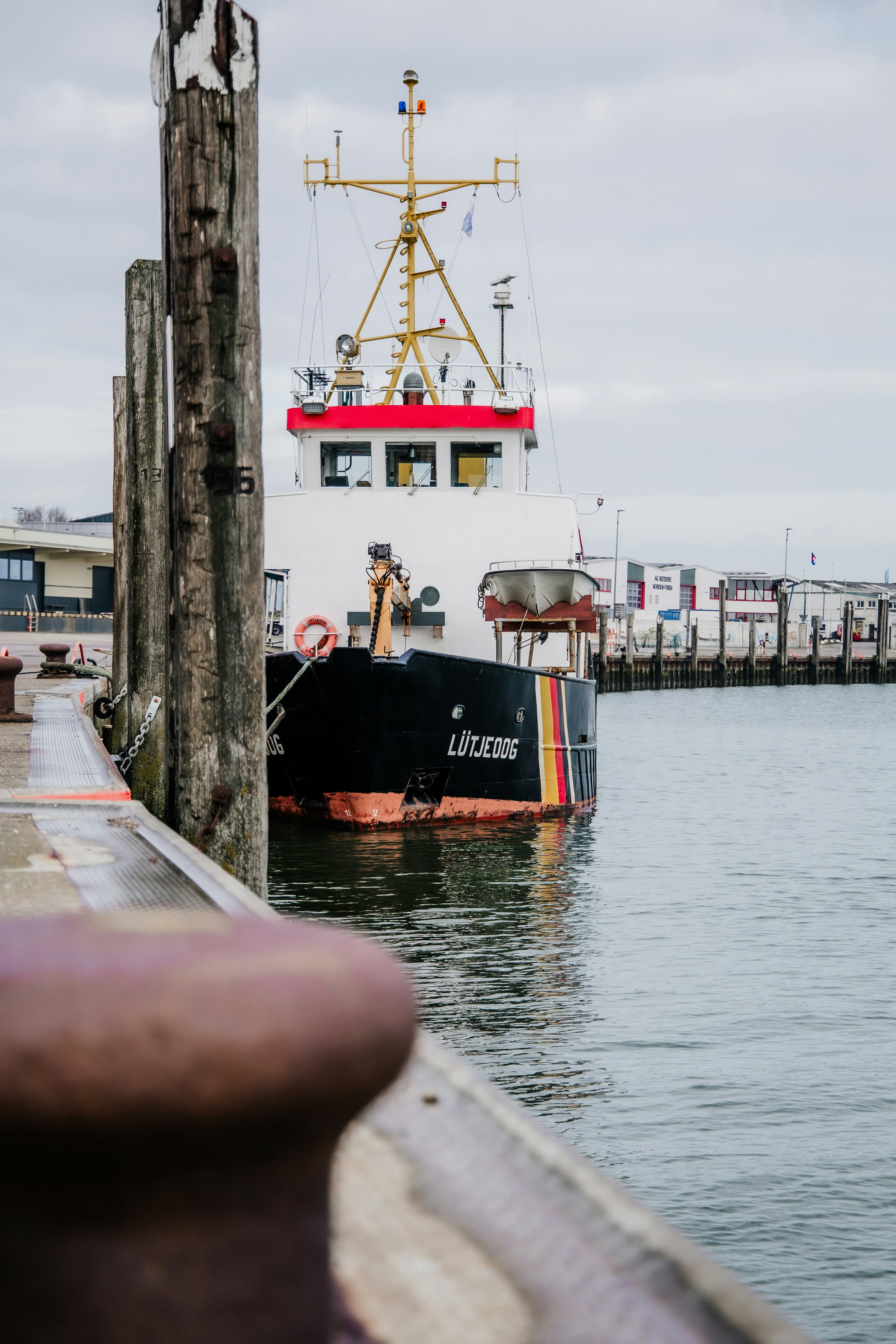 Harbor Tug Parades at Dusk: A Vessel Nuzzled by Piers