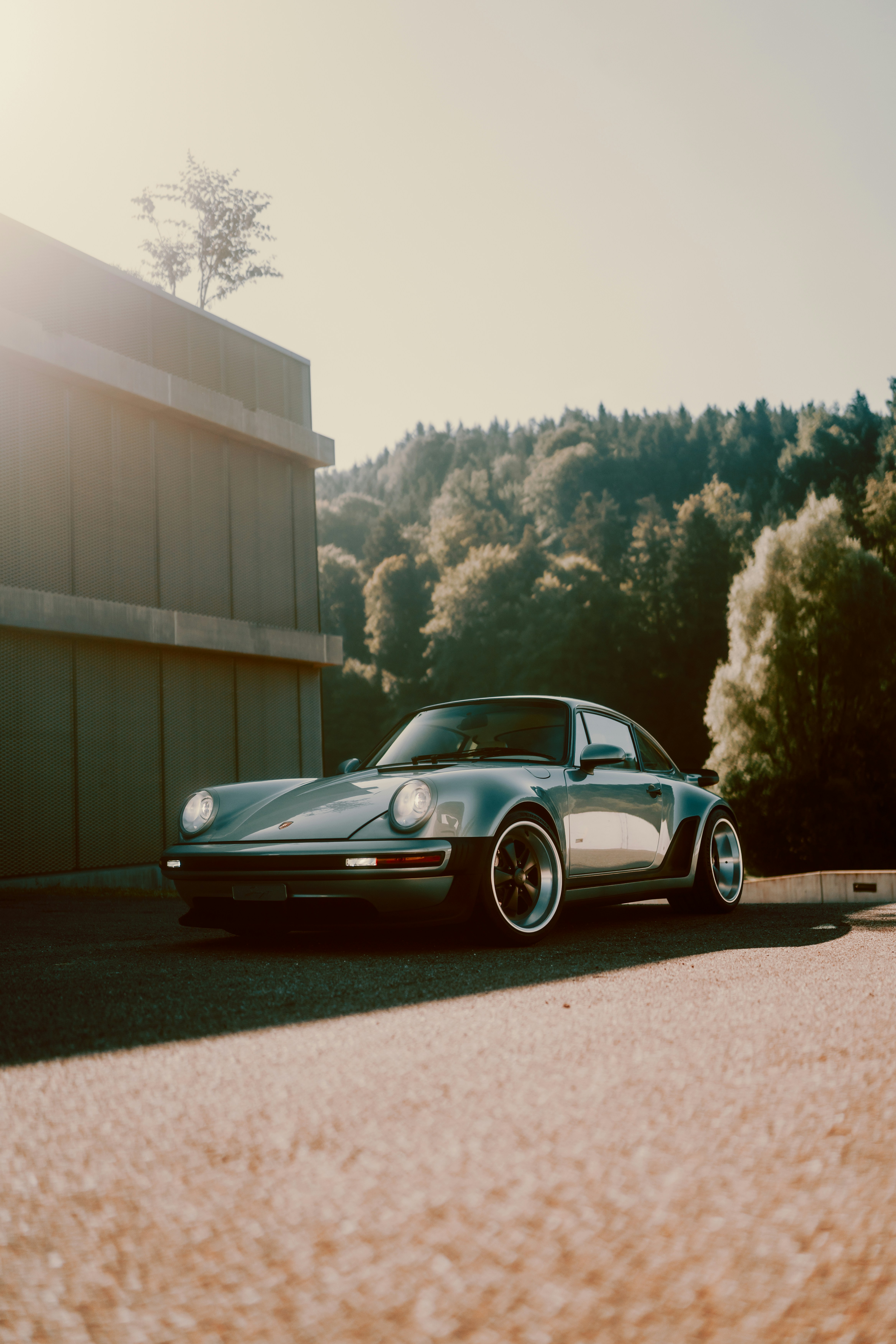Grey Thunder: A Porsche Resting by the Industrial Wall