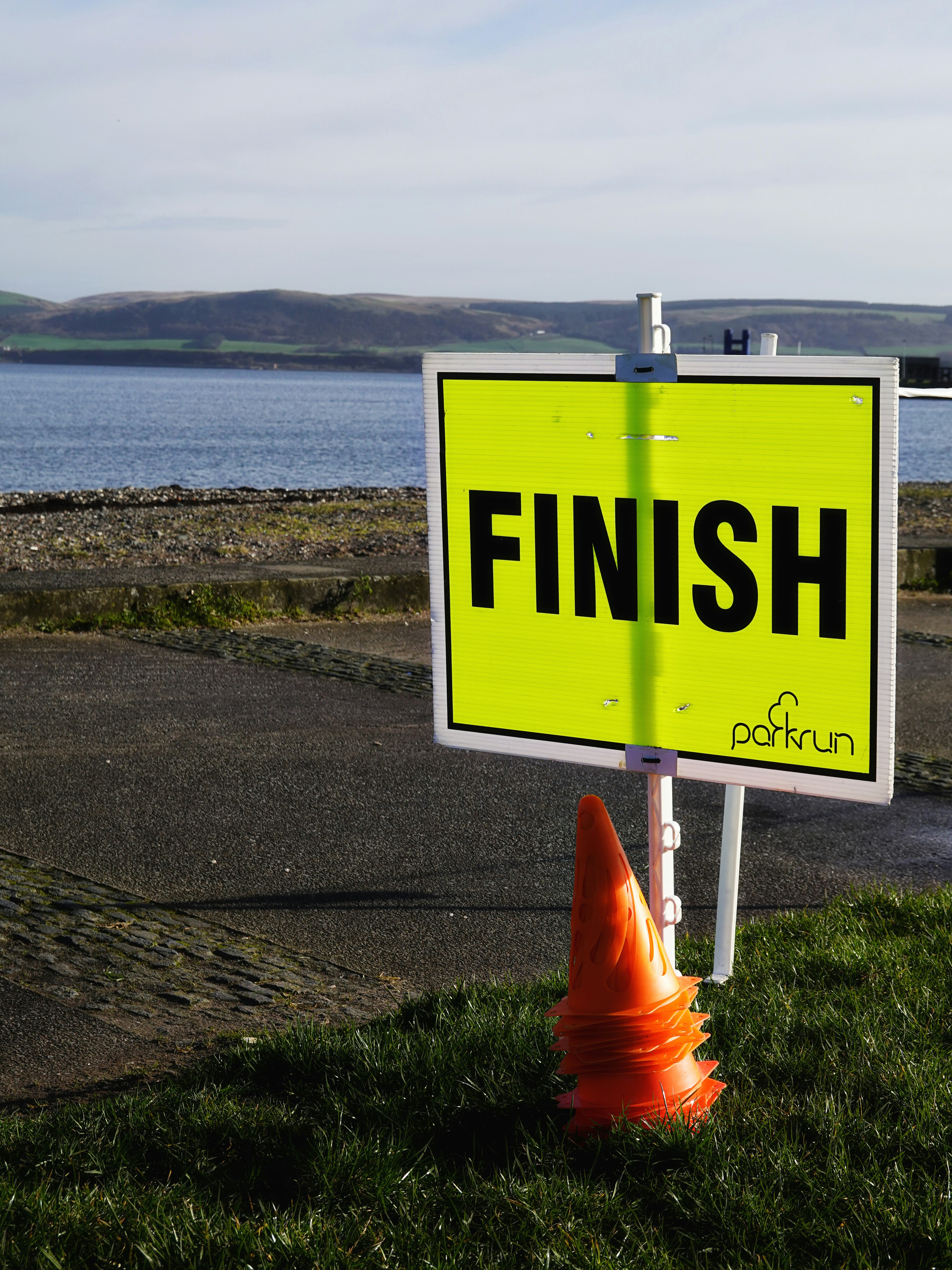 Finish Line by the Lake: A Bright Marker at the Edge of the Track