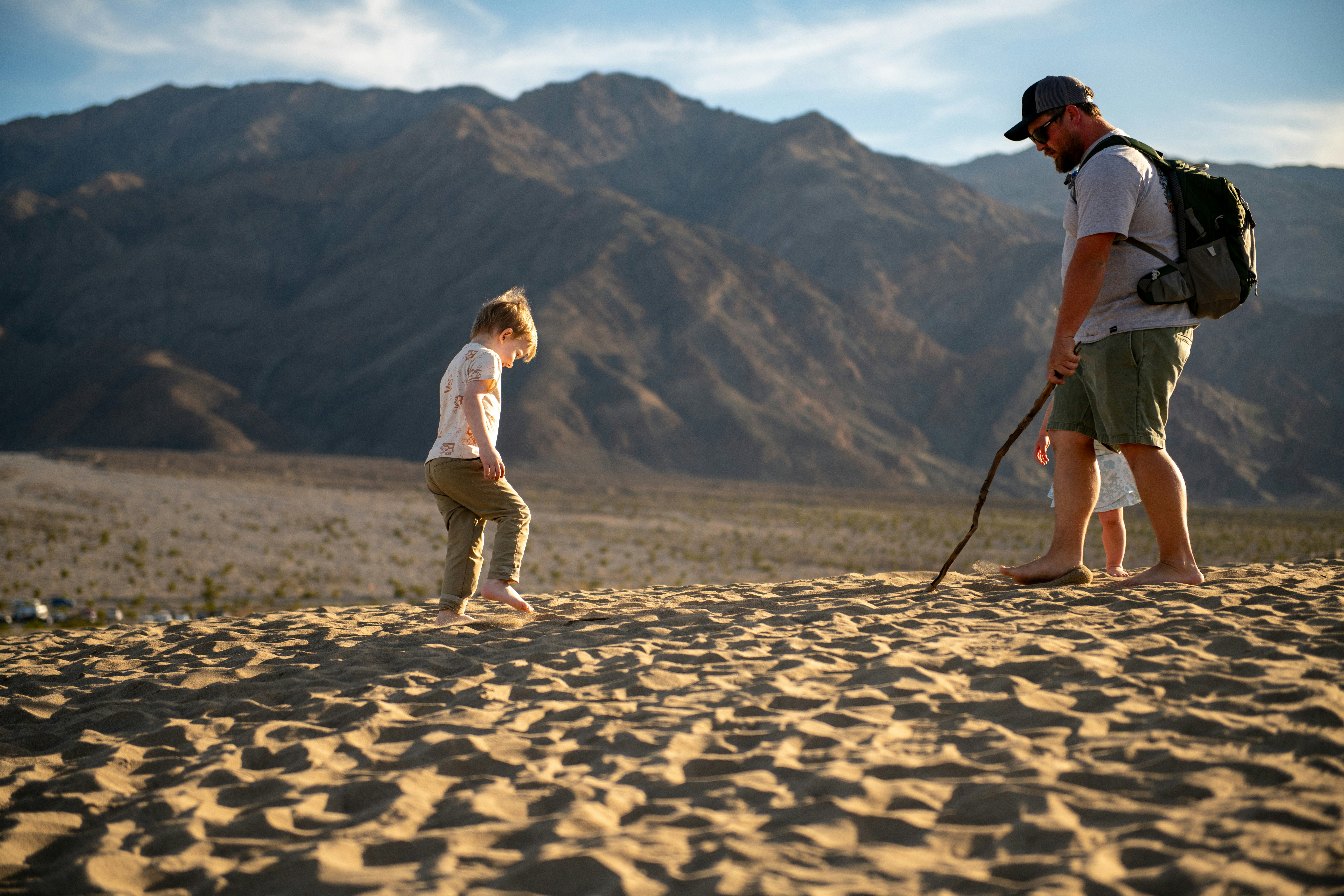 Desert Path: A Father and Child Trek Toward the Distant Peaks