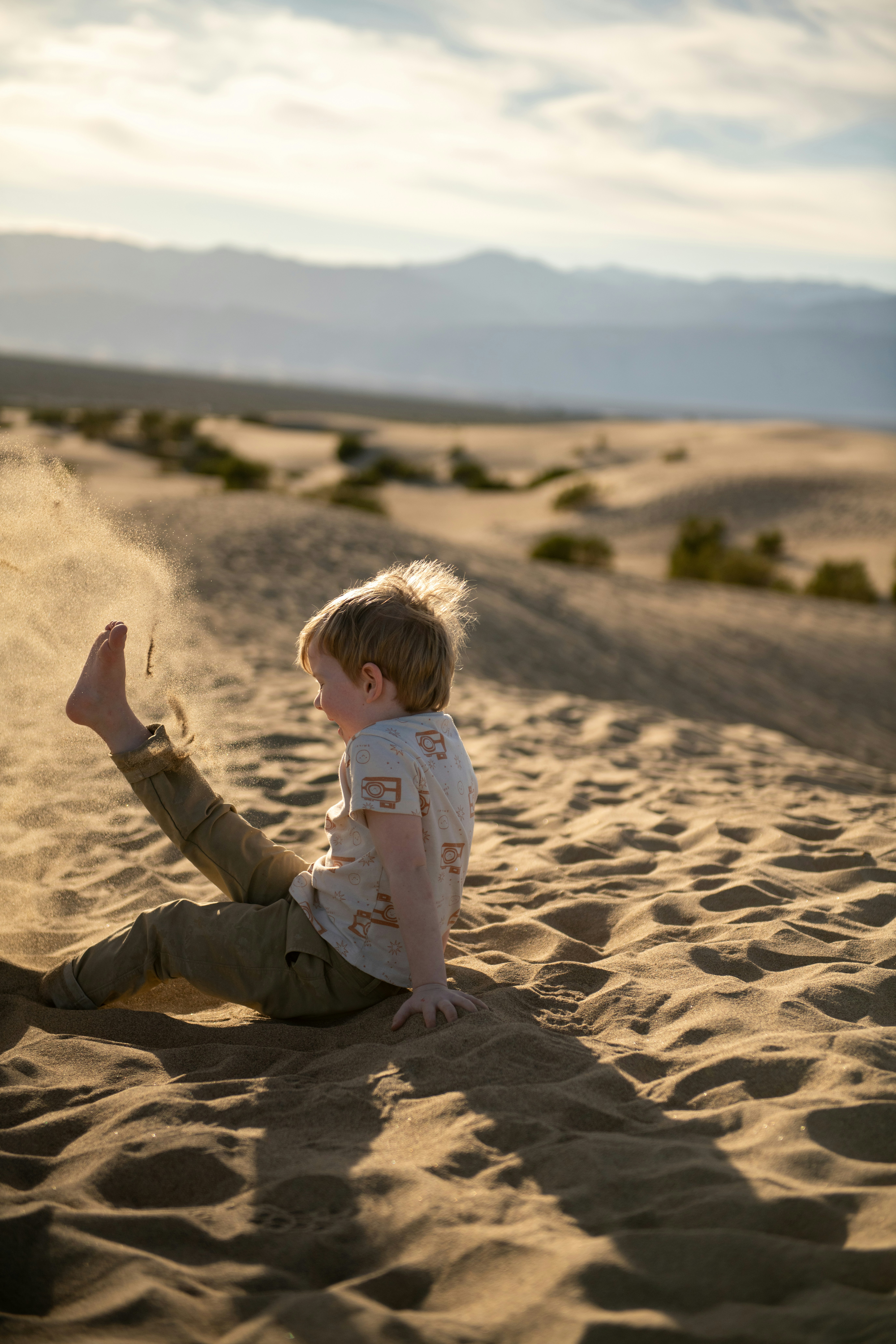 Desert Child at Play: A Lone Moment on Warm Sand