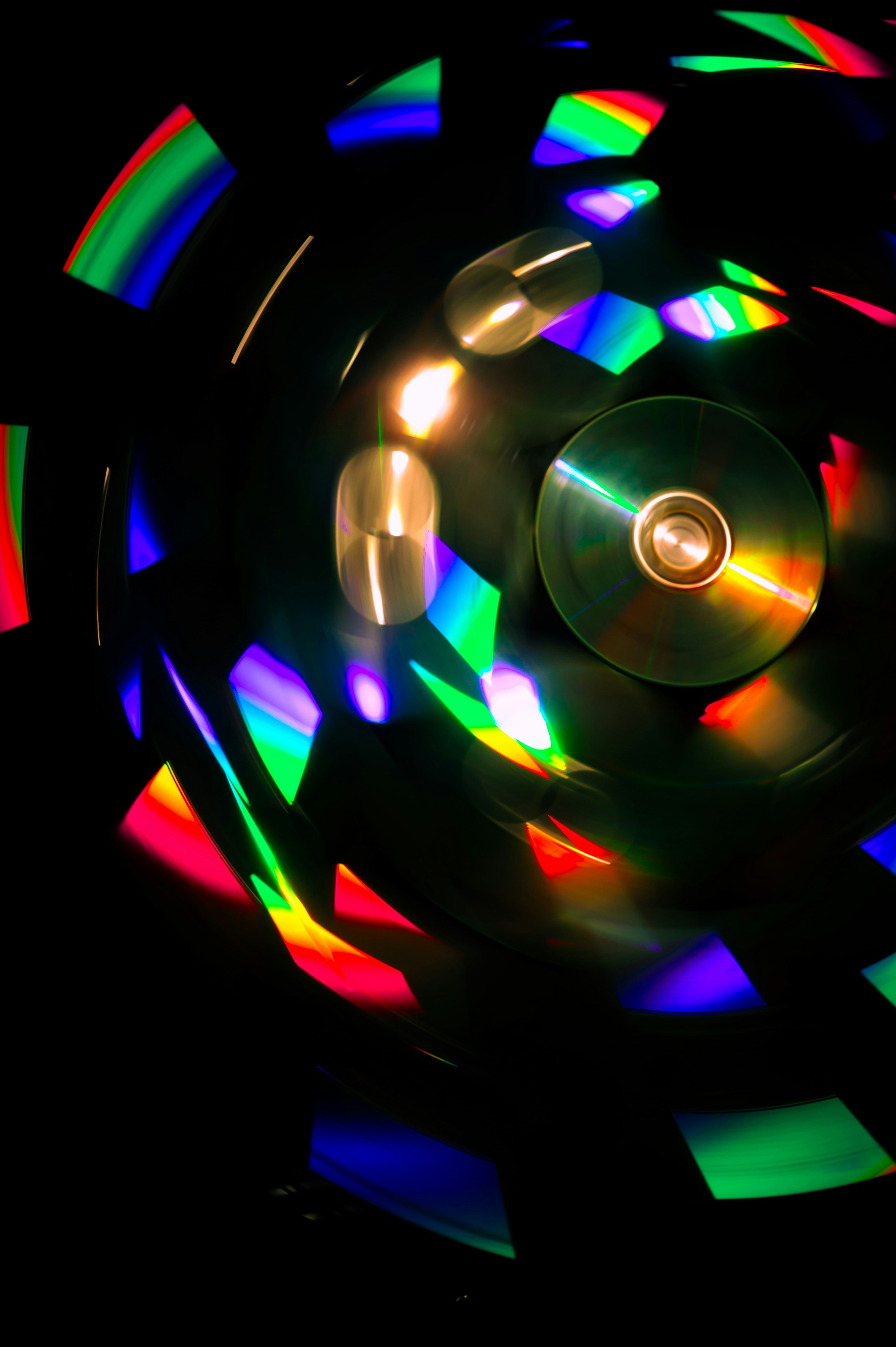 Prismatic CD: A Rainbow Cyclone Encircling a Central Disc