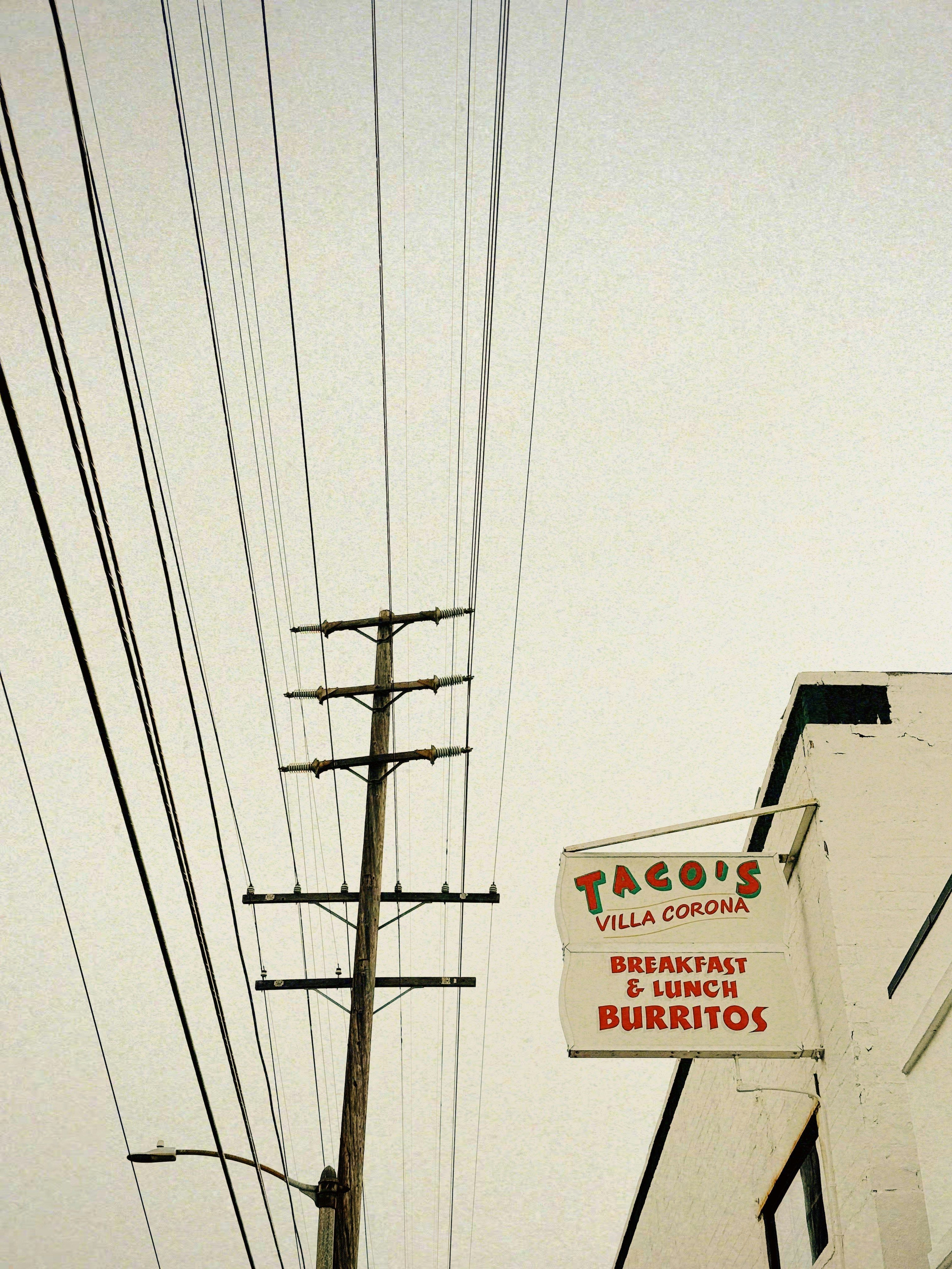 Taco's villa corona sign with telephone poles