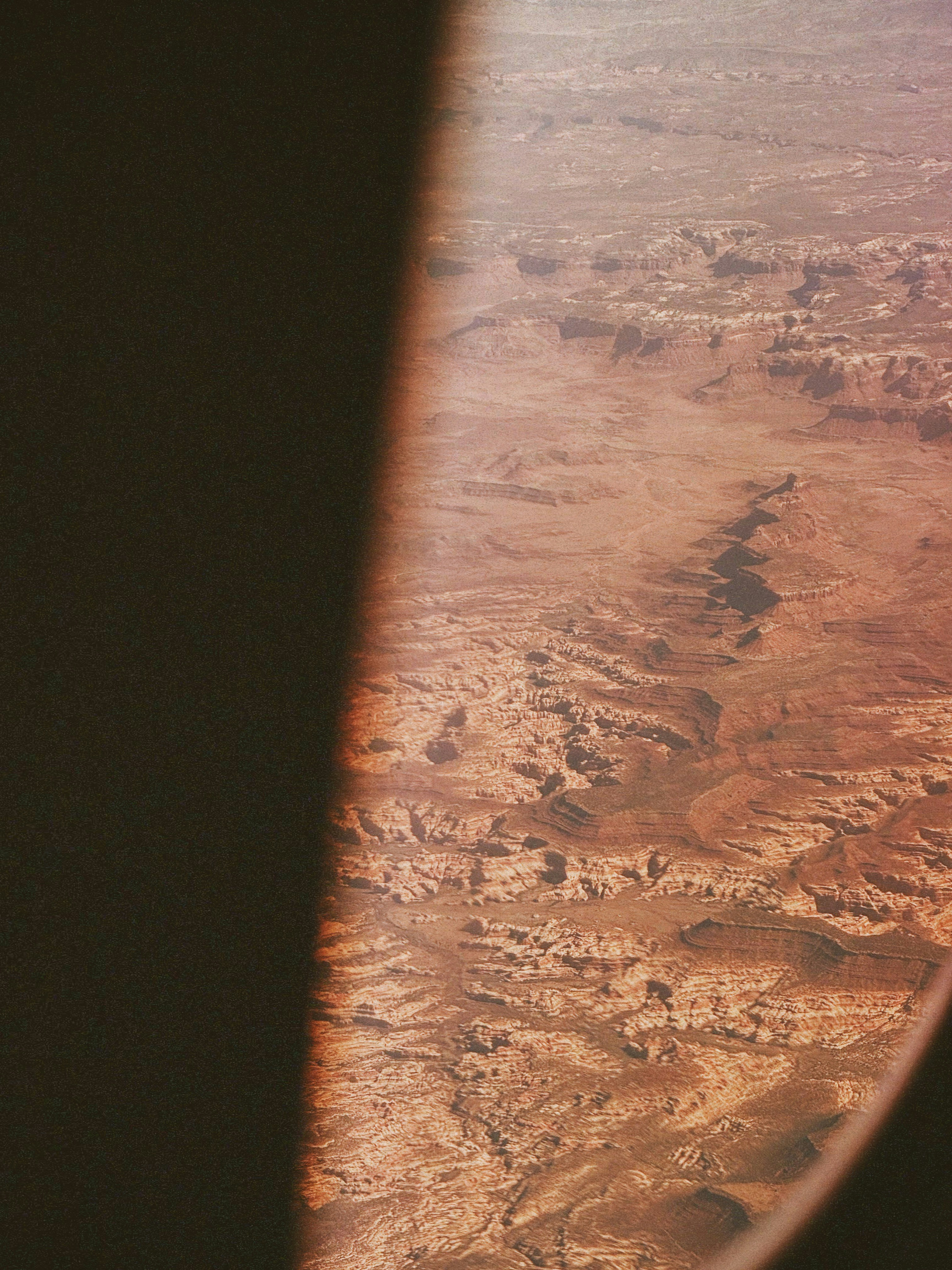 Shadowed Rim and Textured Desert: A Close Crop of Earthy Curves