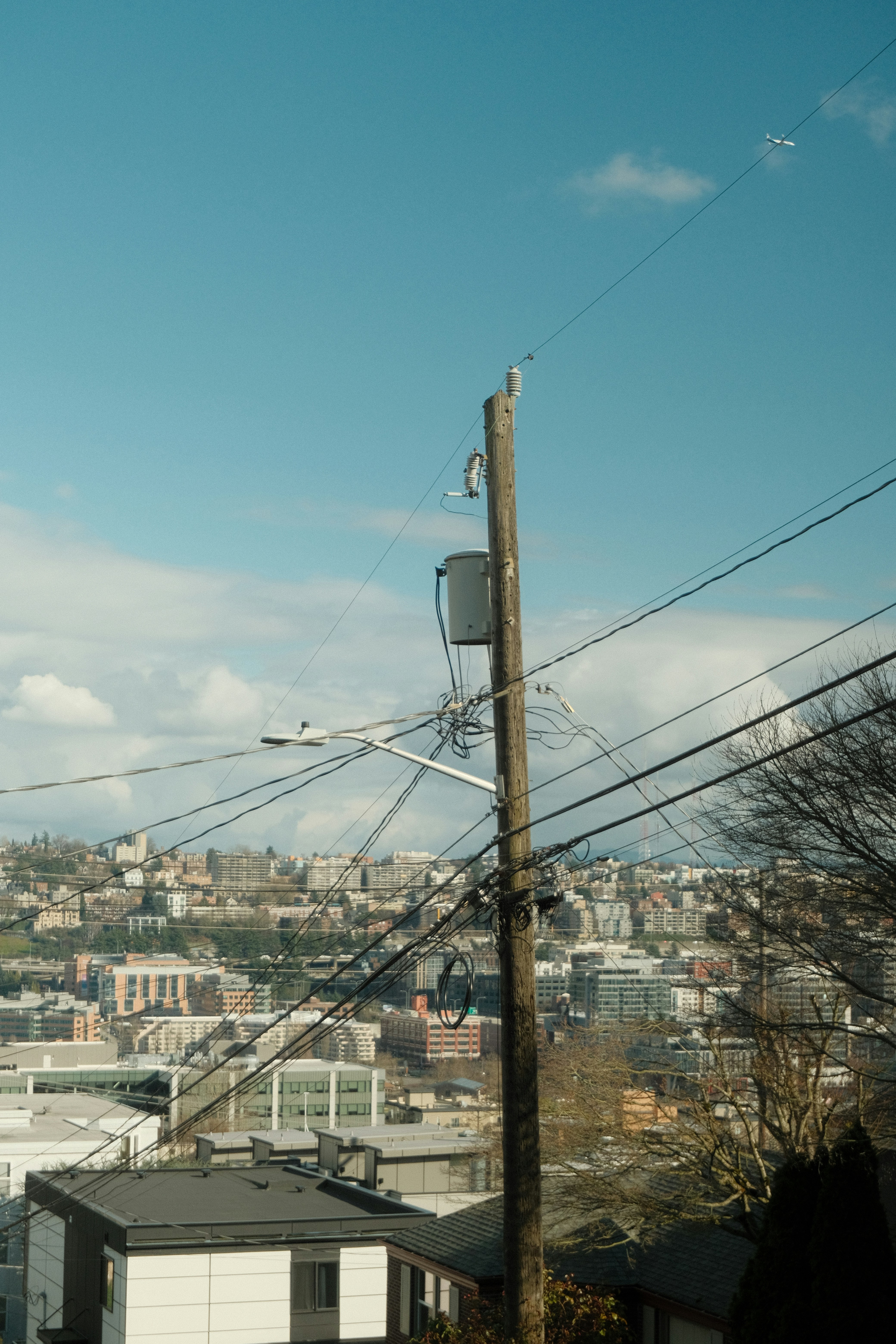 Urban Skyline Amid Power Lines and Pole