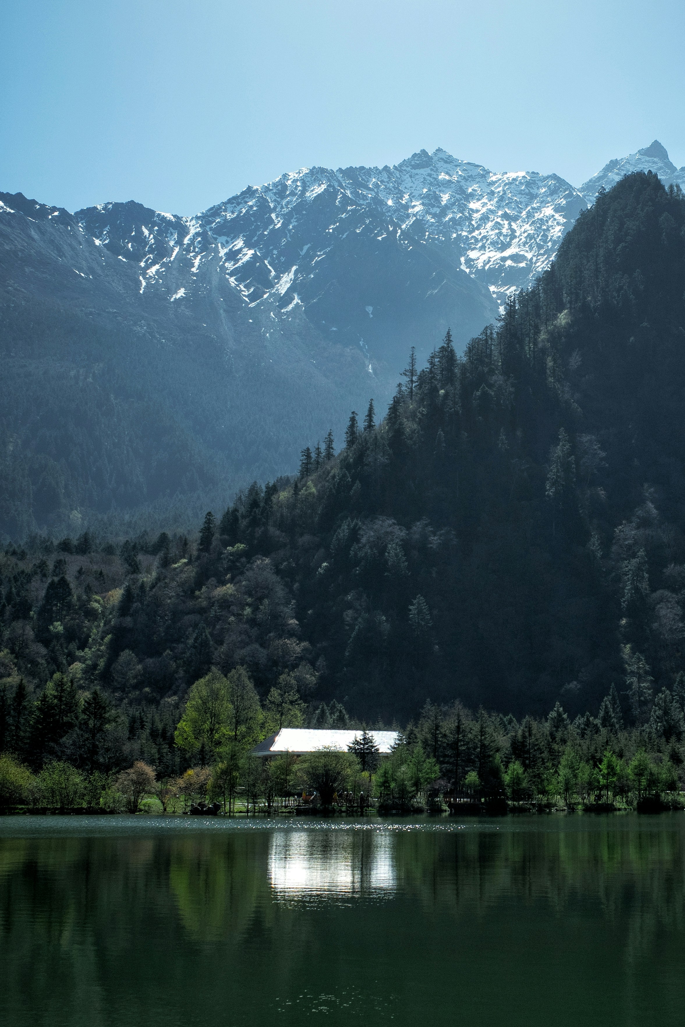Snow-kissed Peaks Over a Quiet Lake Chalet