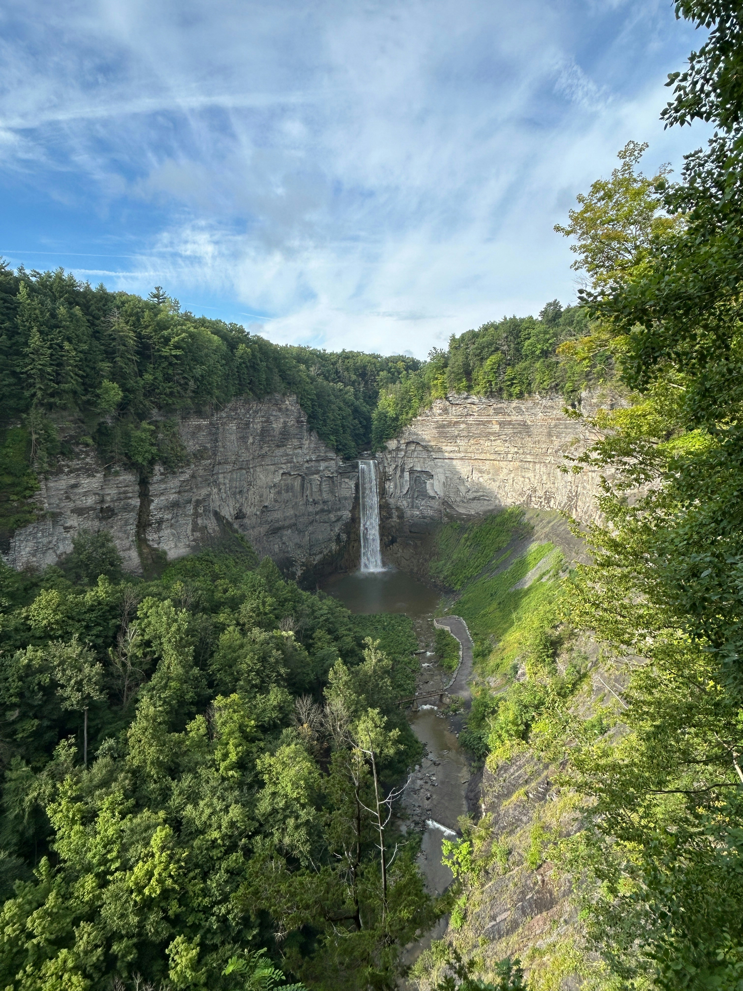 Cascading Silence: A Waterfall Carved into Verdant Cliffs